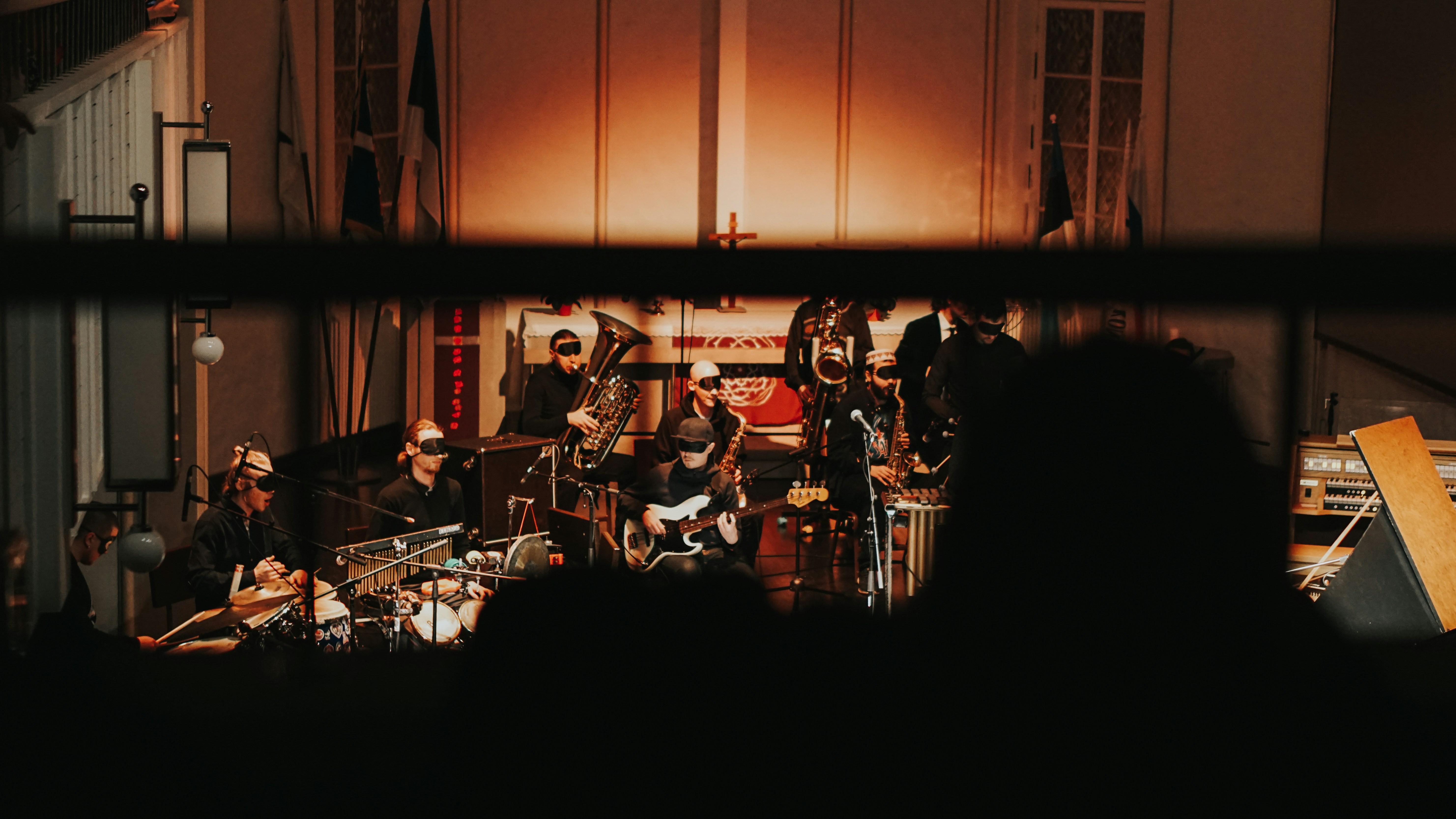 Midnight Jam: A Band Illuminated in Shadowed Rehearsal
