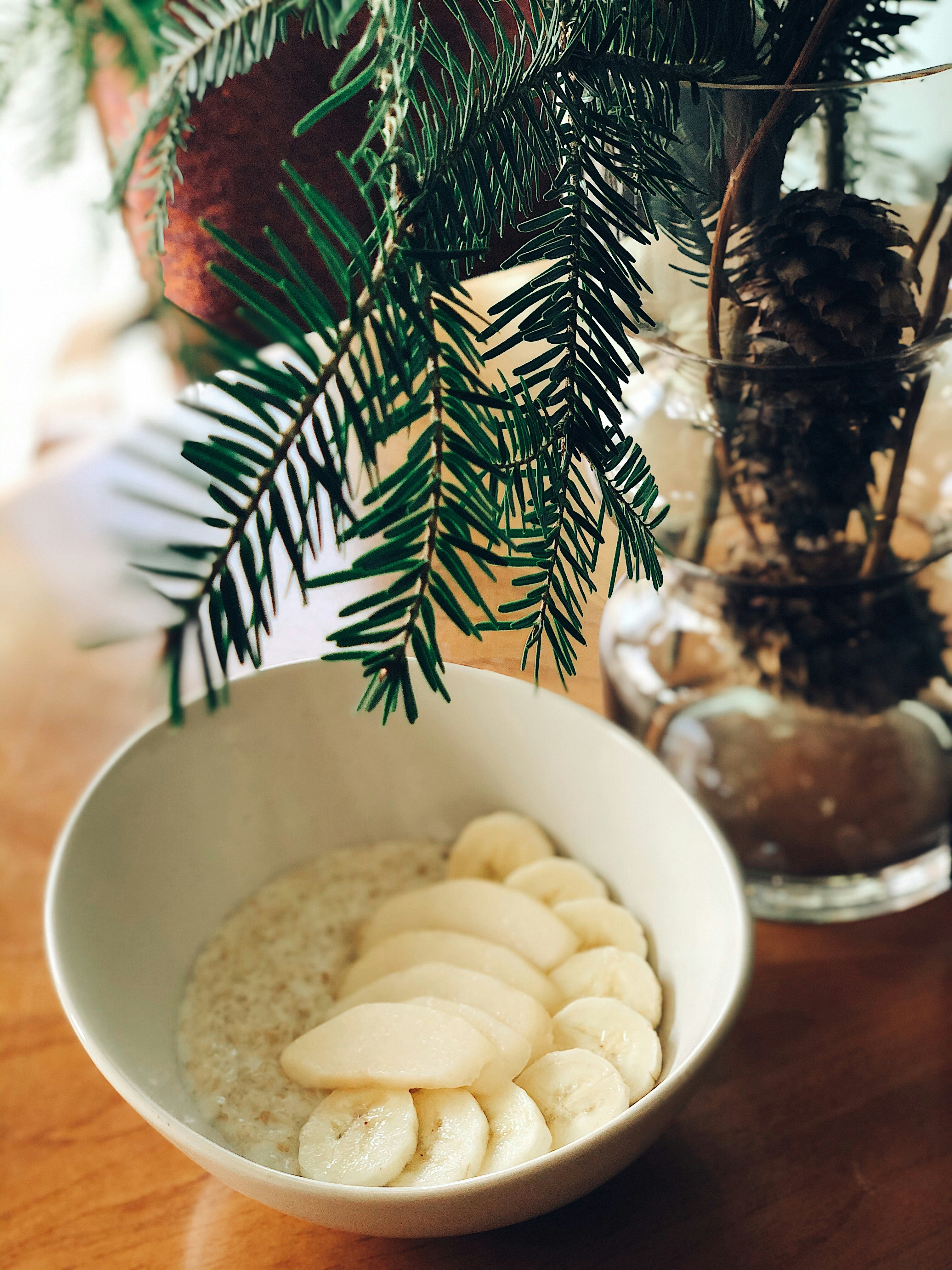 Verdant Frame: Banana Oat Bowl Under Holiday Foliage