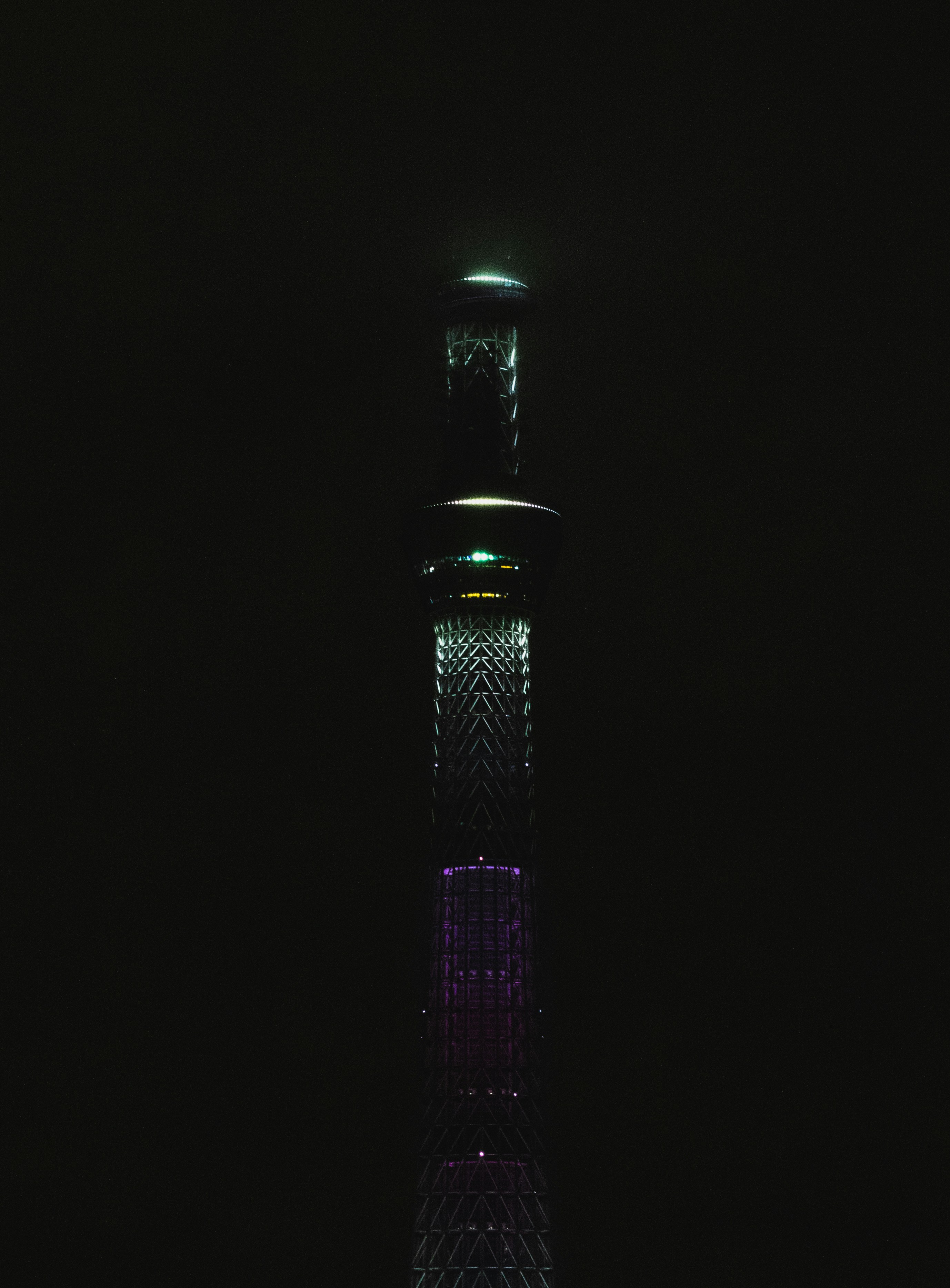 a tall tower lit up in the dark