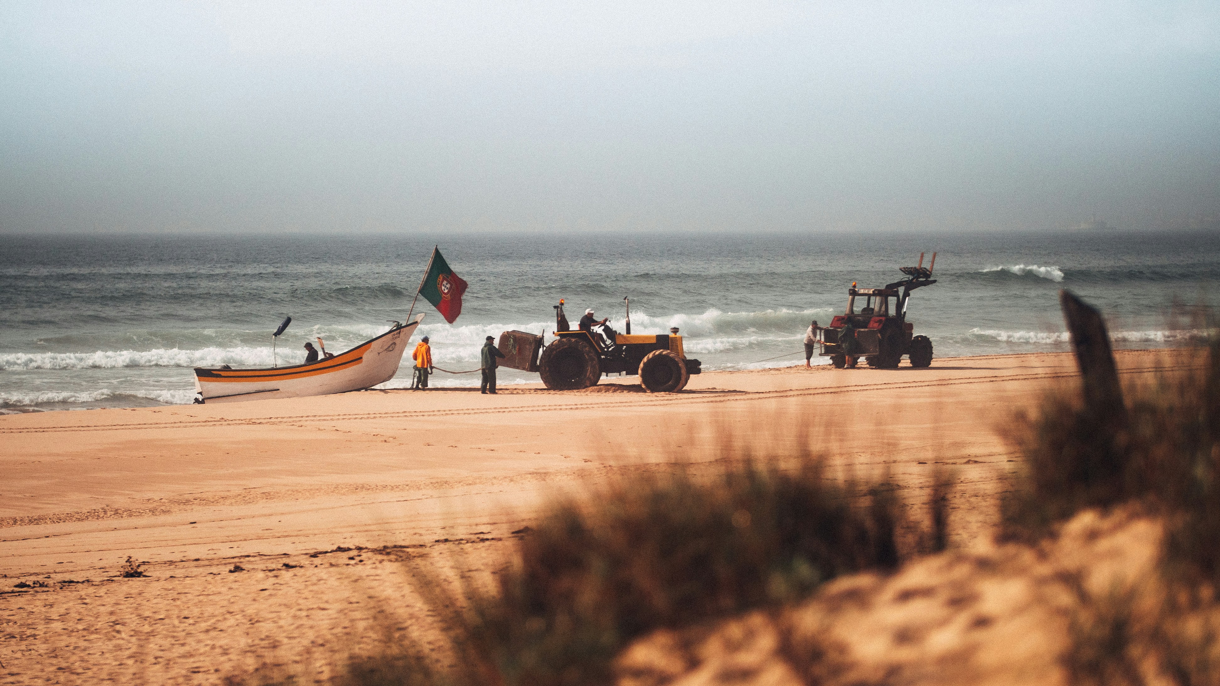 Photography of two person standing beside vehicle and boat near ...