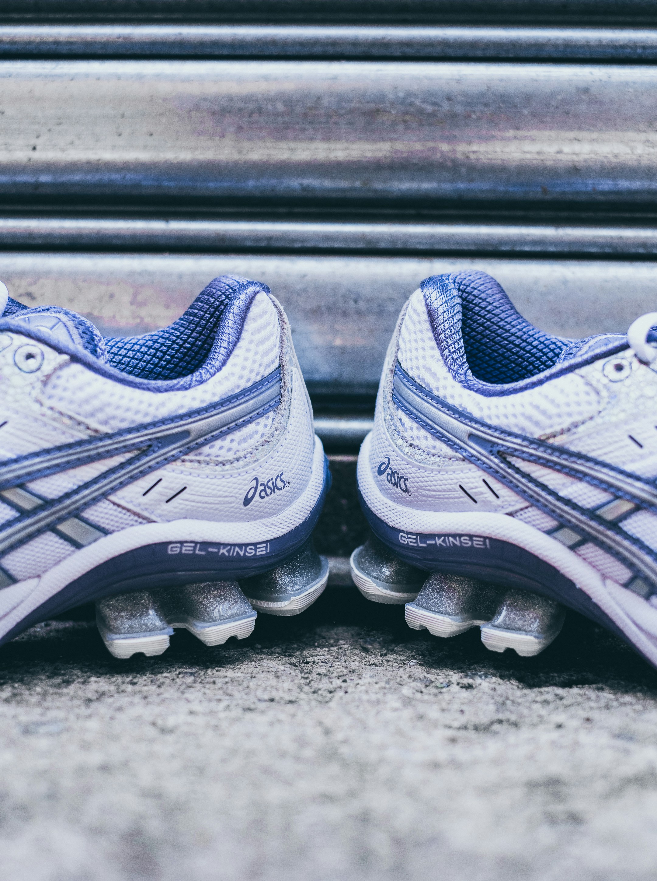 Symmetry in Sole: ASICS Gel-Kinsei Pairs Resting Along a Metallic Backdrop