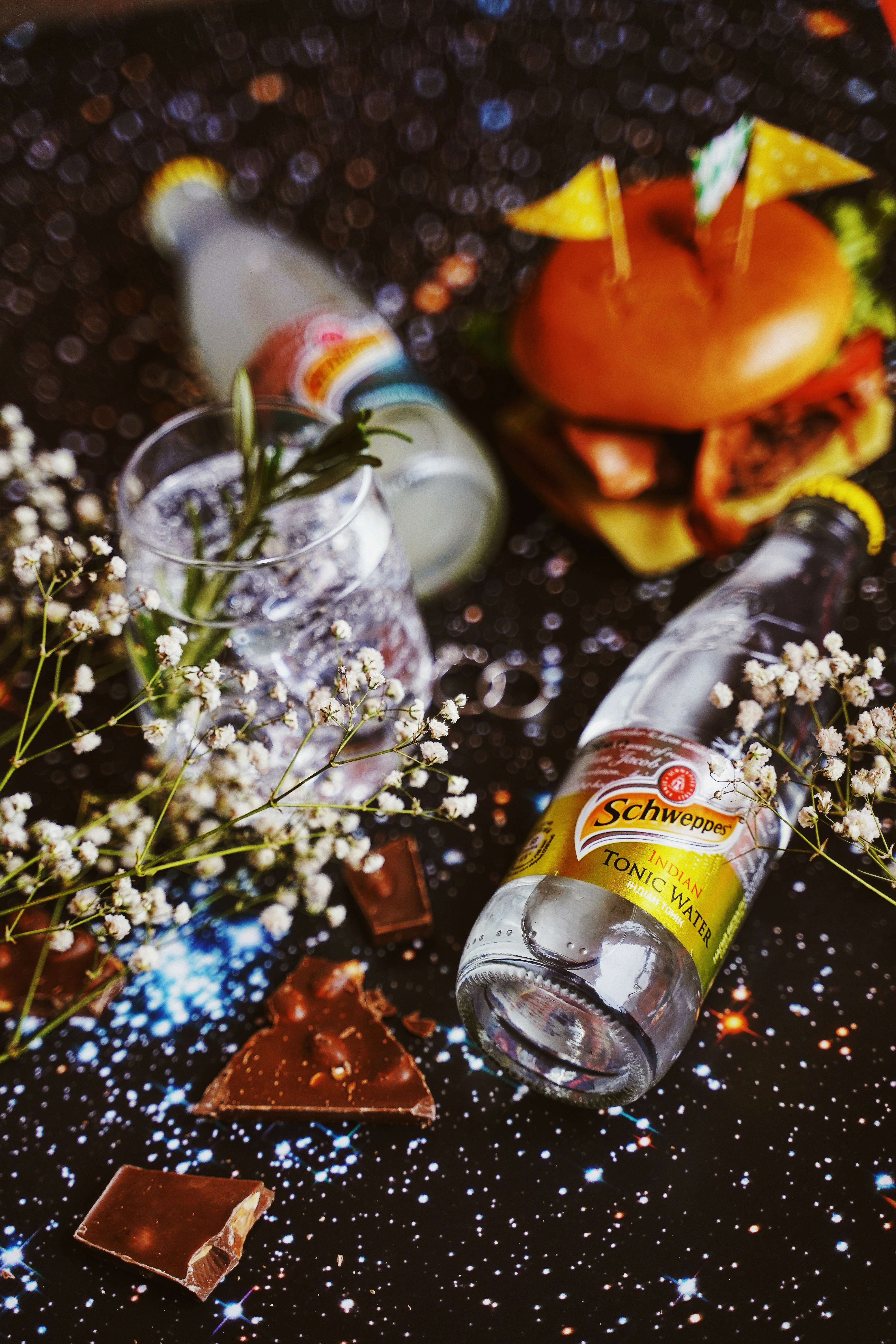 macro photography of two glass bottles and tulip wine glass