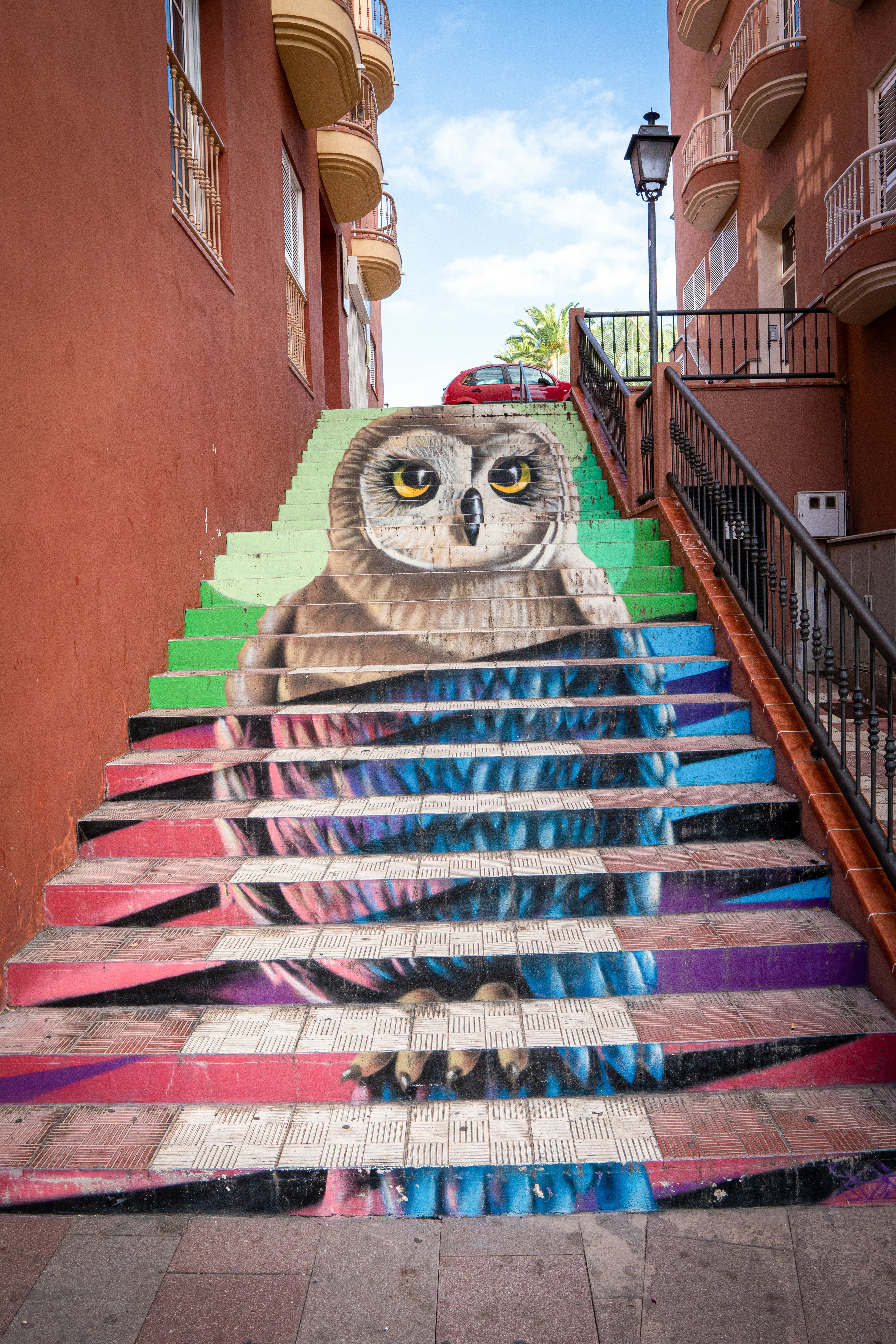 Owl on Neon Steps: A Painted Staircase in the City