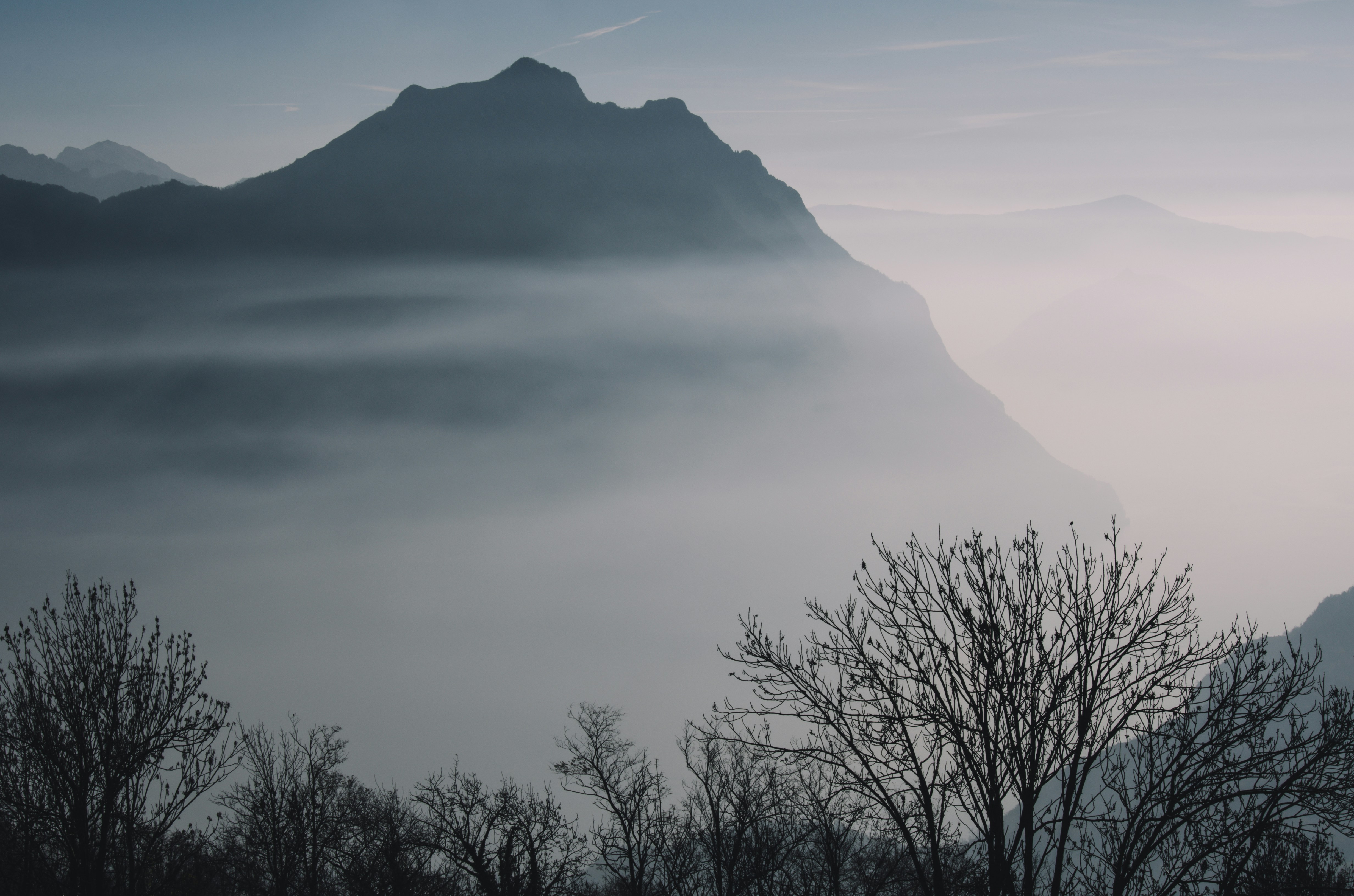 Mist-Wrapped Summit: Mountain Peak in Winter Fog