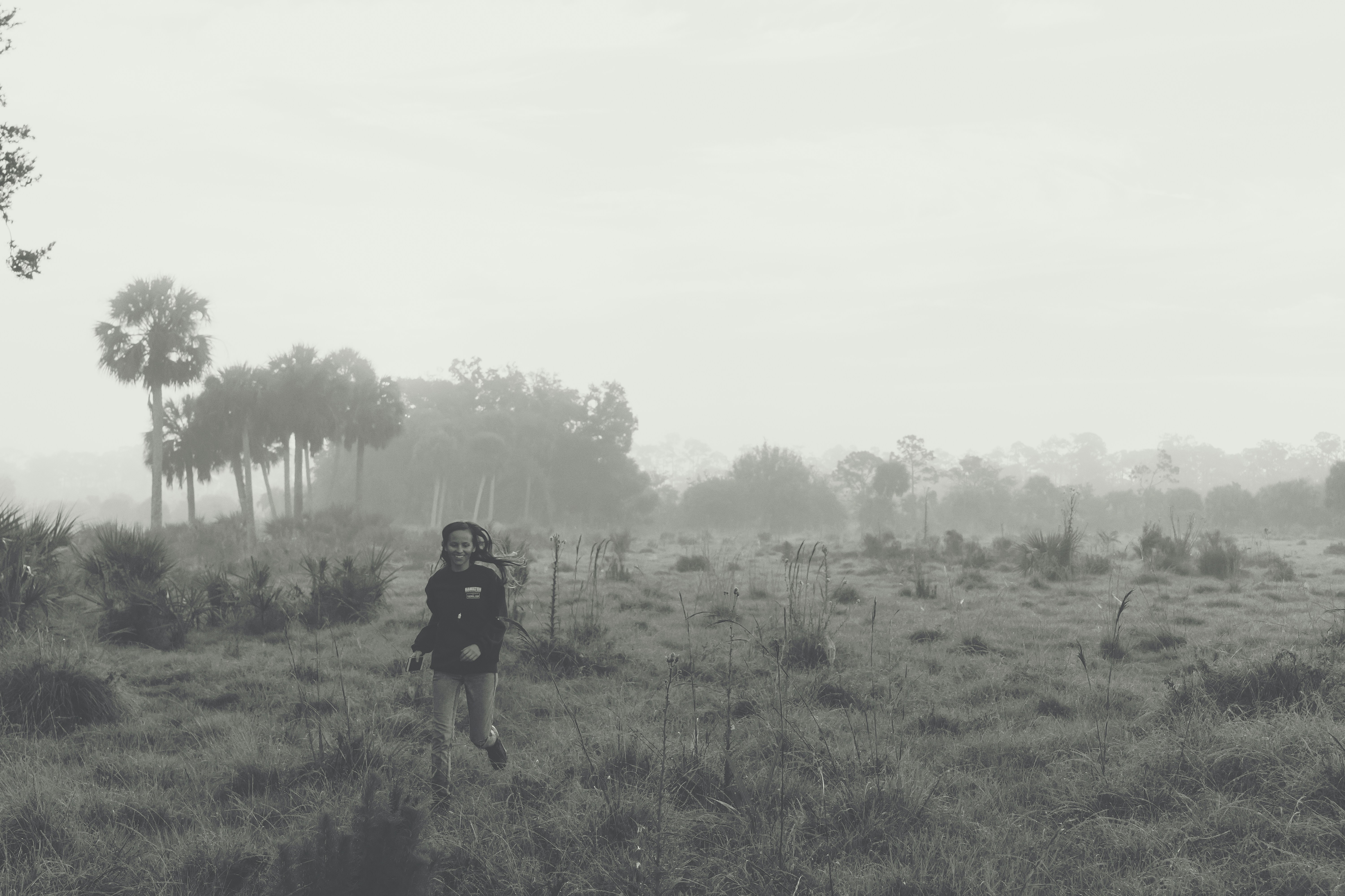 Lone Runner in a Misty Plain: A Quiet Monochrome Moment