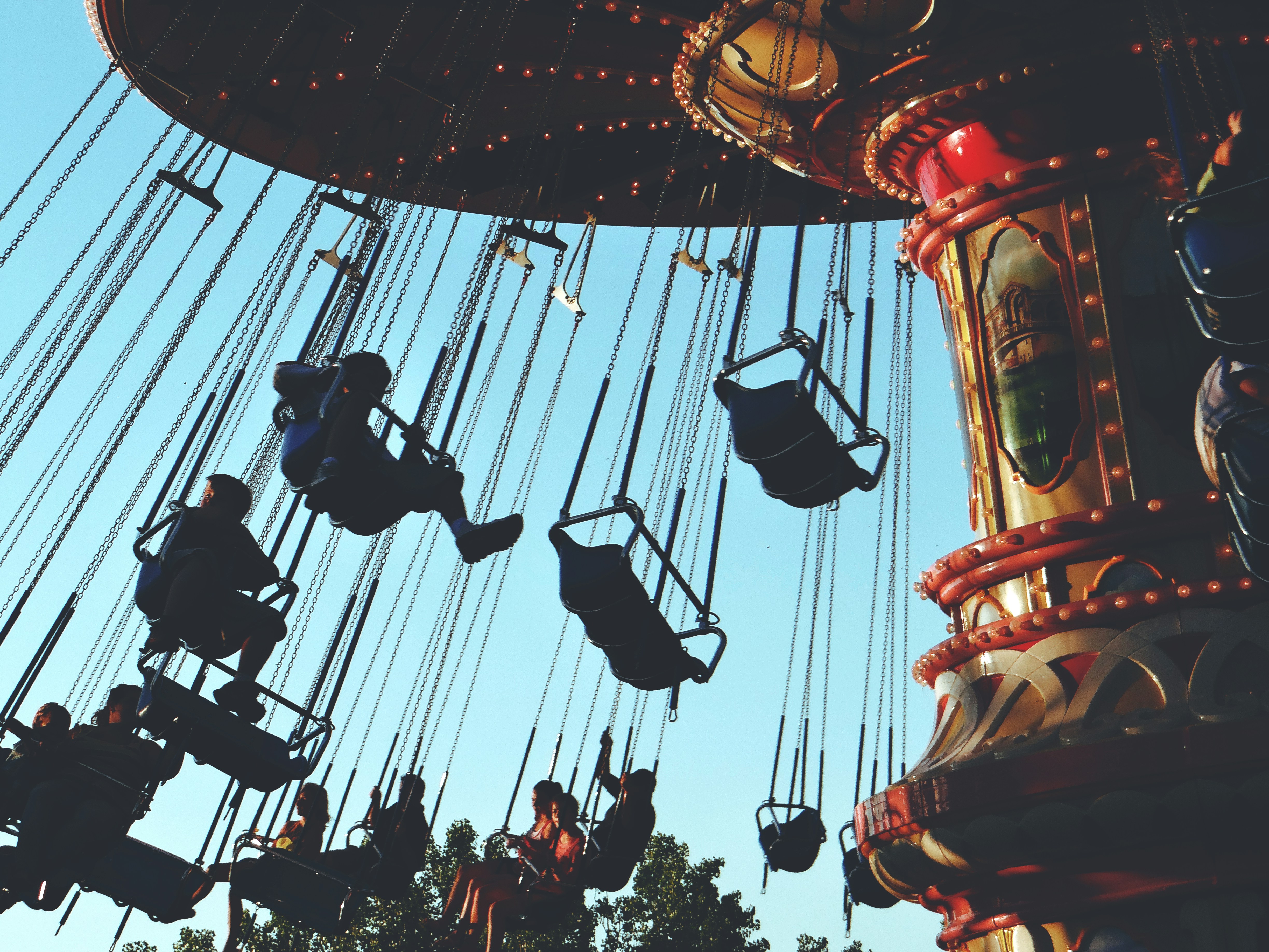 Low-angle photo of people riding rotating theme park ride photo – Free ...