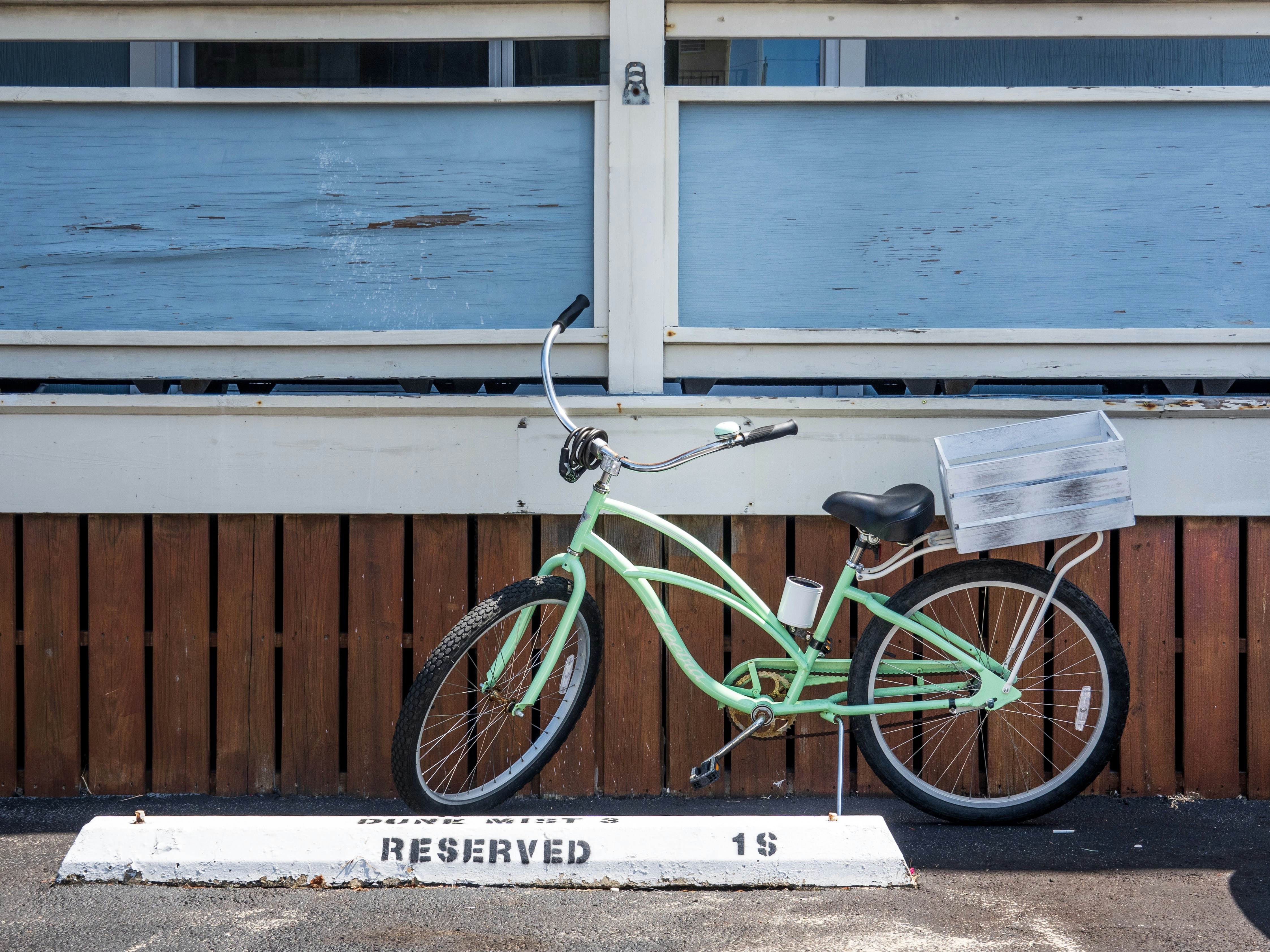 Green commuter bike leaning on wall photo – Free Ocean city Image on ...