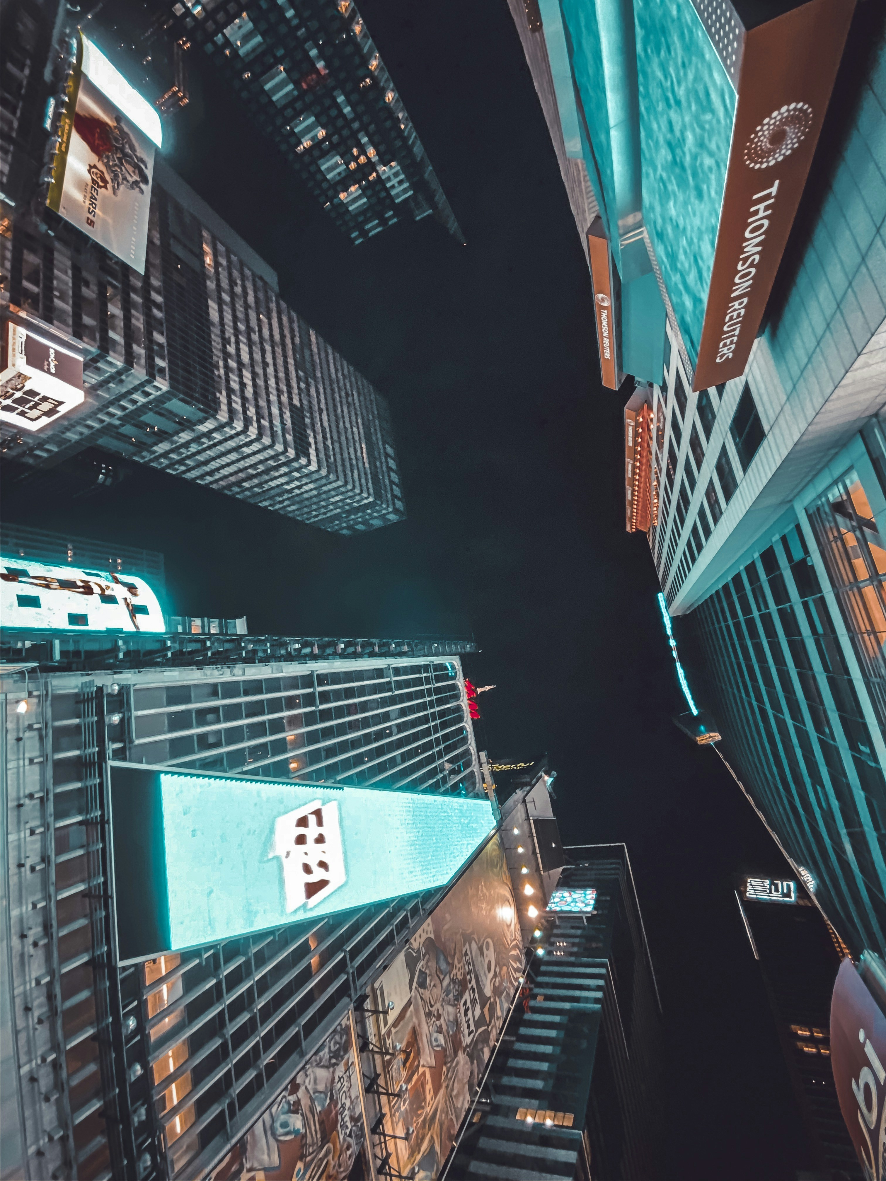 Blue Neon Beacon Between Glass Giants
