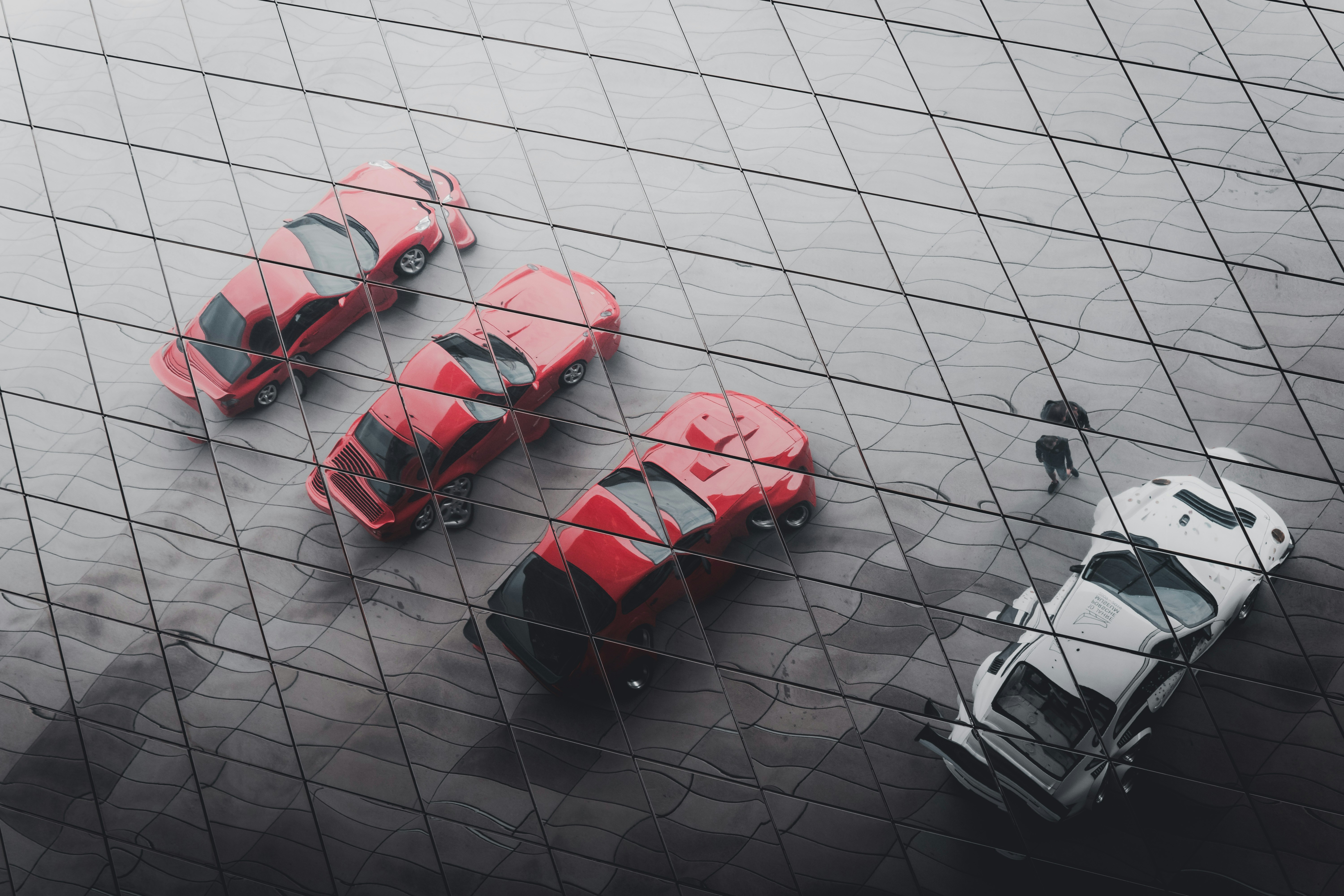 Three red vehicles parked beside white vehicle photo – Free Animal ...