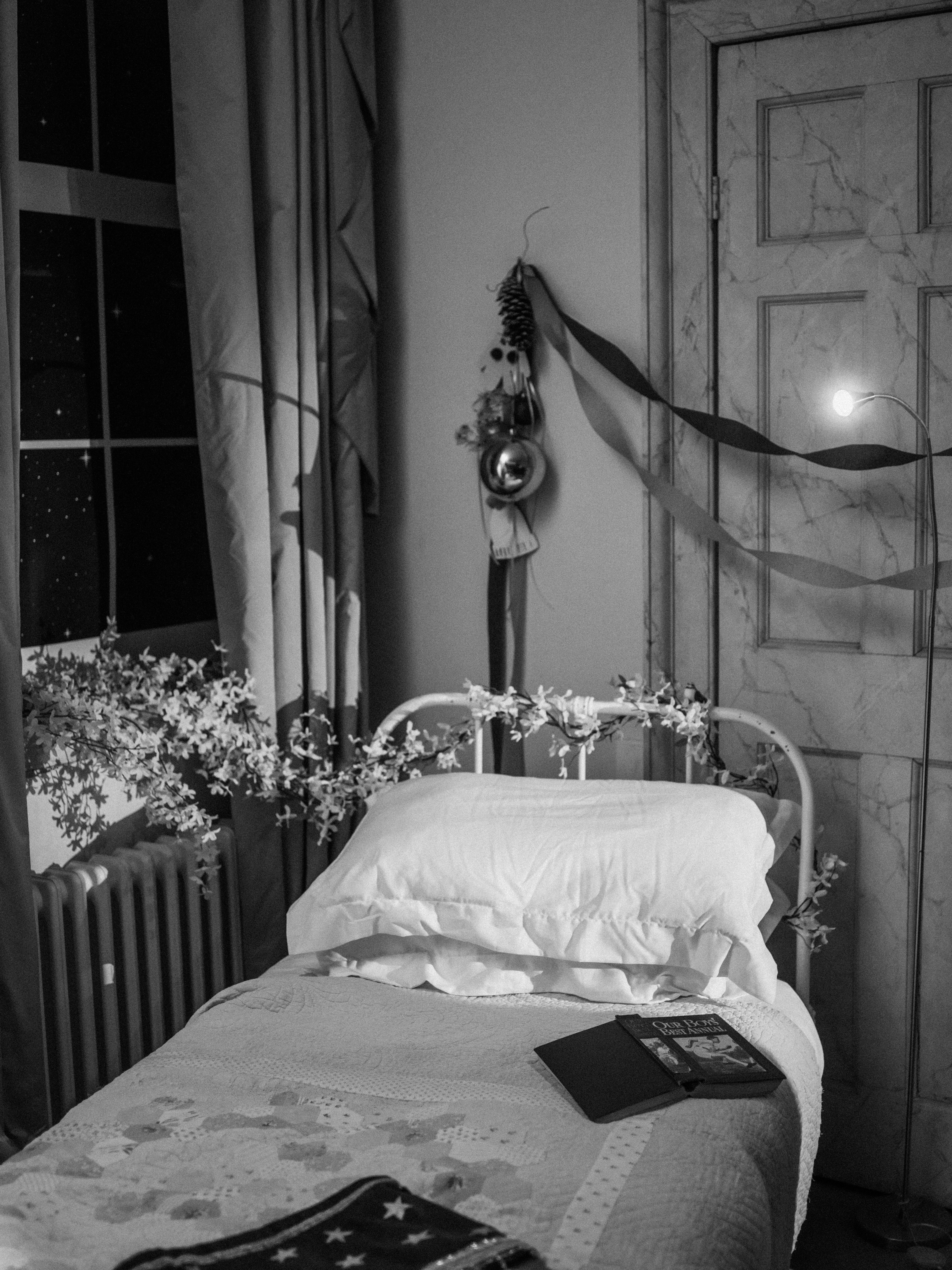 Monochrome Bedroom: Garlanded Bed with Ribbon Streamers and an Open Book