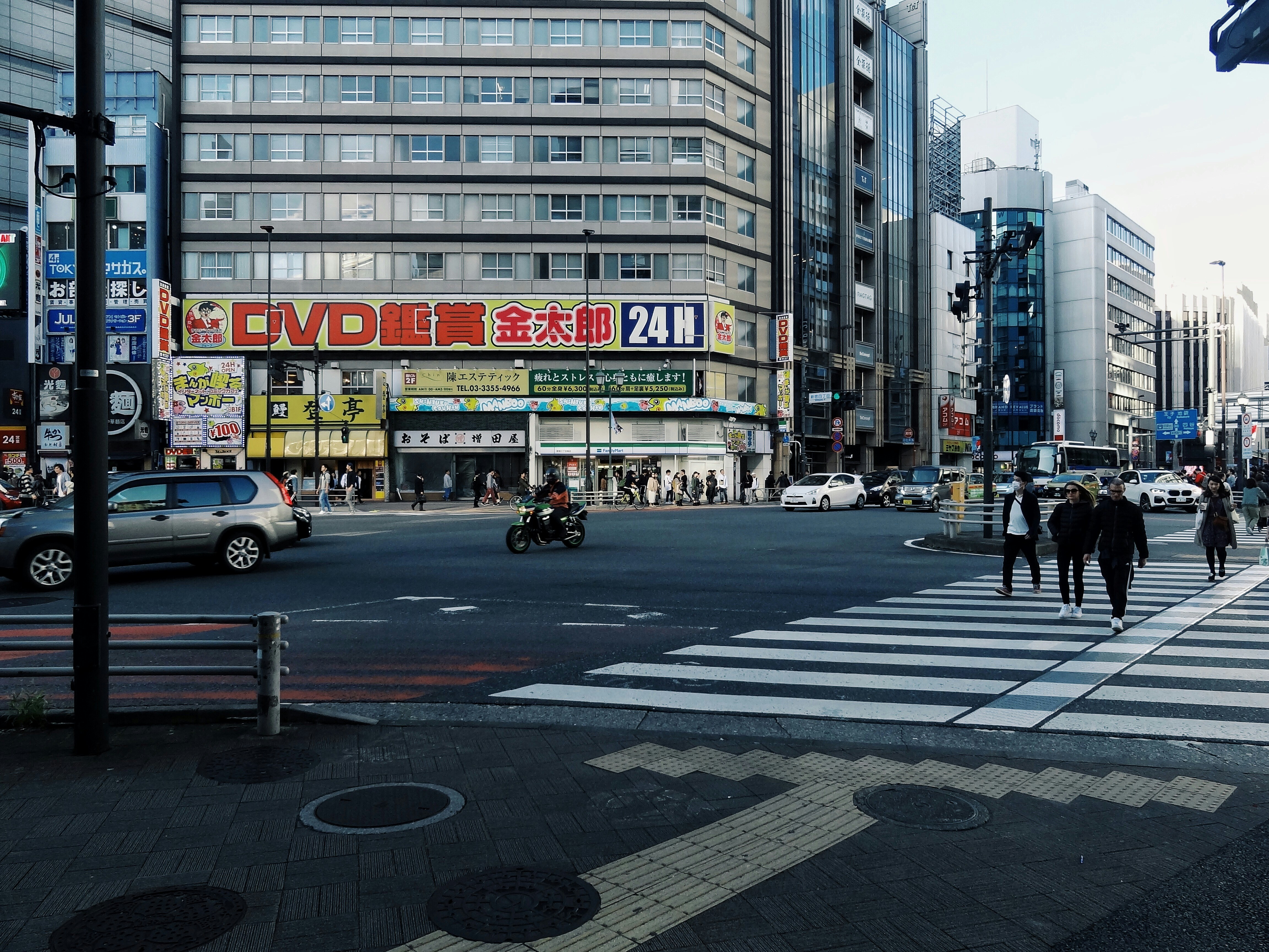 People crossing street between buildings photo – Free Road Image on ...