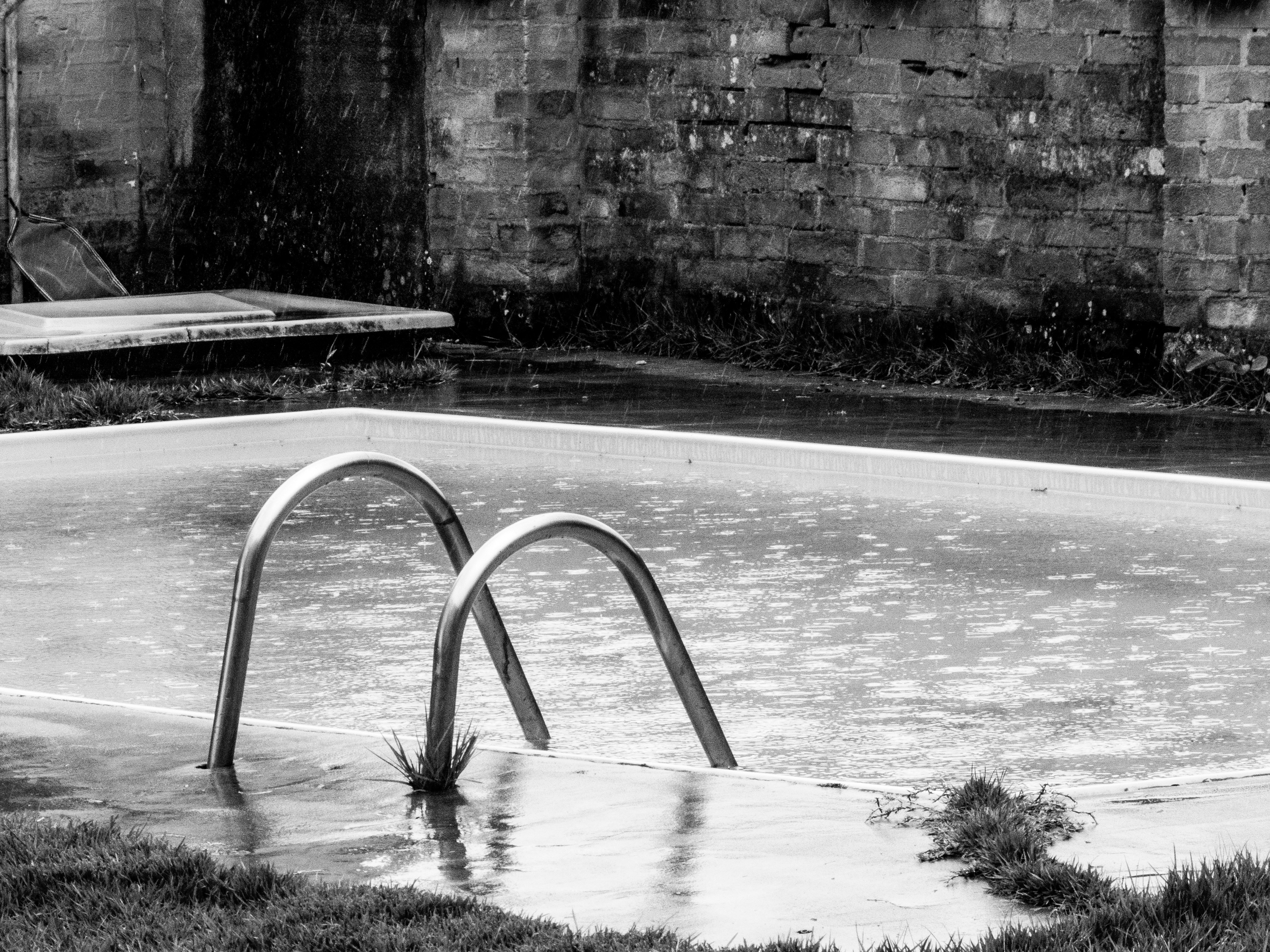 Two Steel Arches in a Silent, Rain-Washed Pool