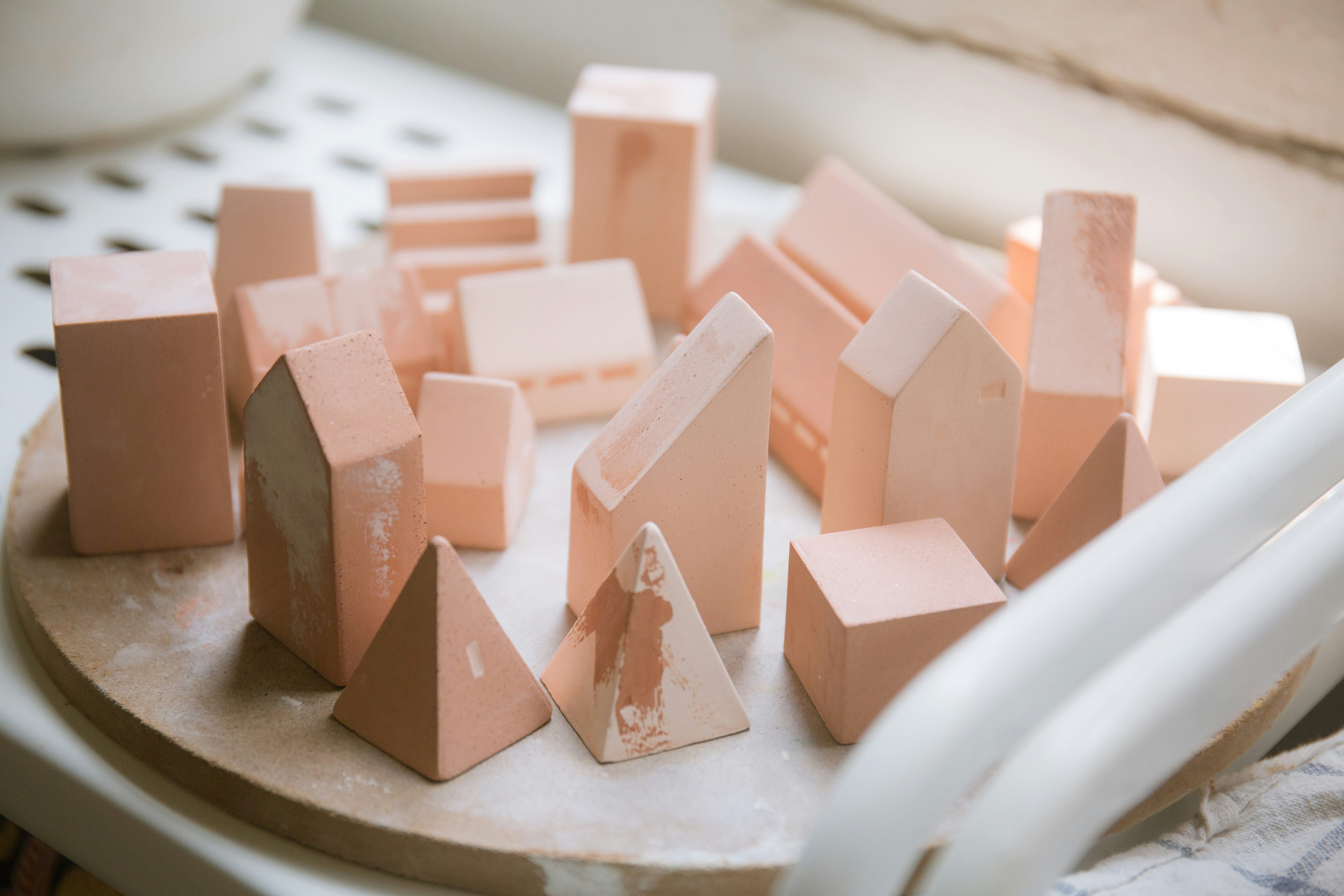 Pastel Prism: Geometric Clay Forms on a Marble-tinged Plate