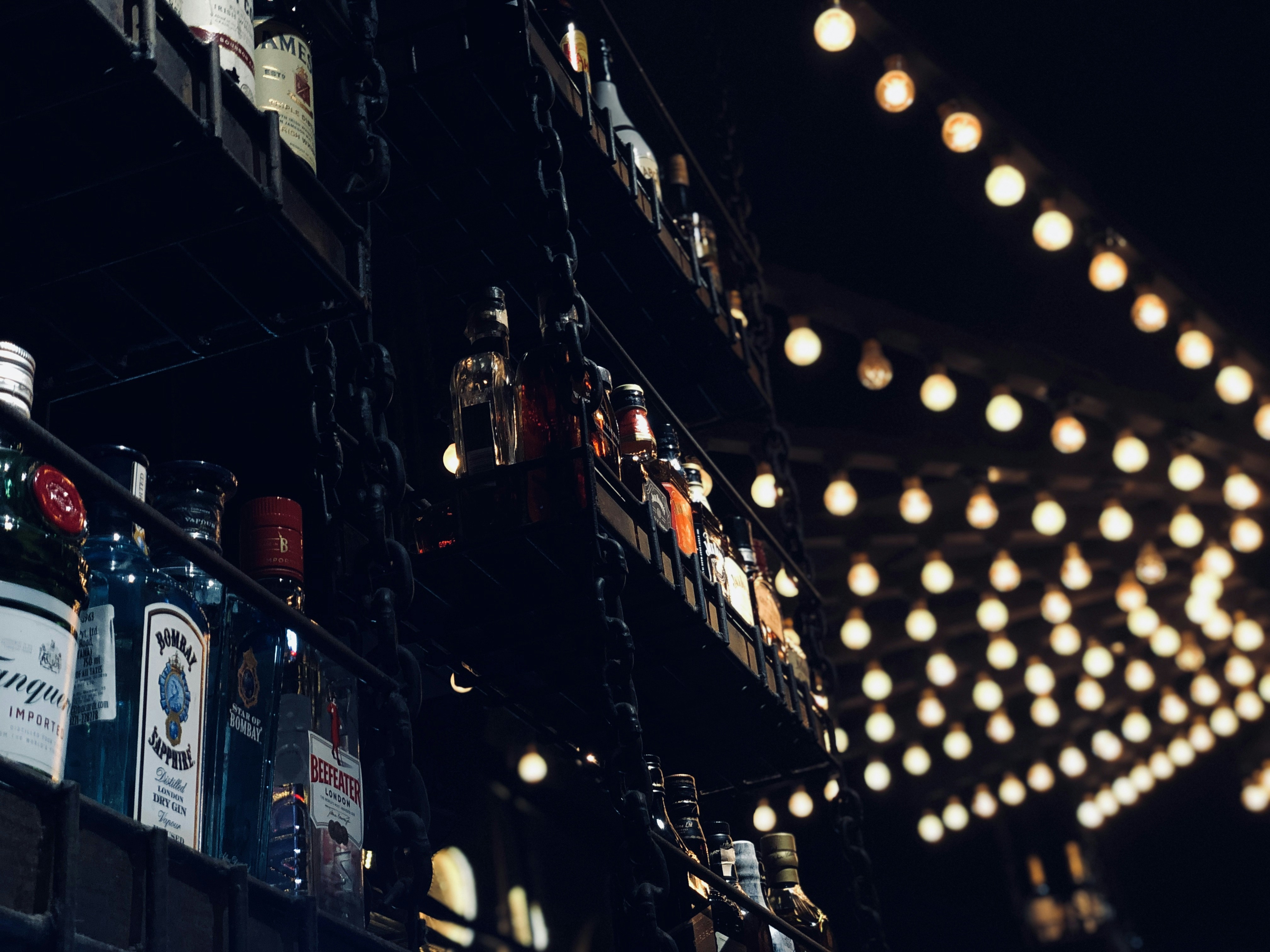 Rows of Amber Bottles Under a String-Light Constellation