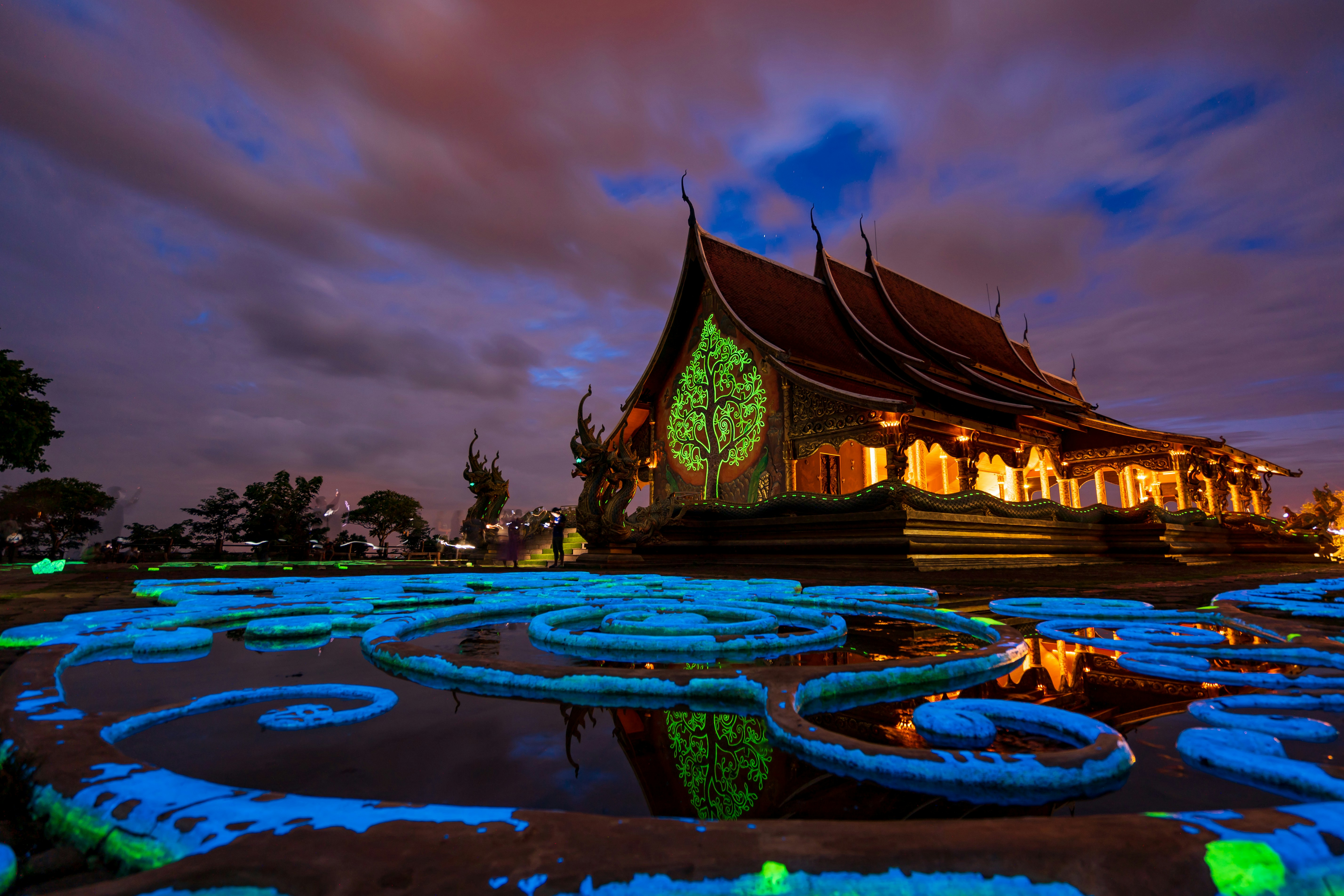Lighted water fountain beside wooden house at night photo – Free ...