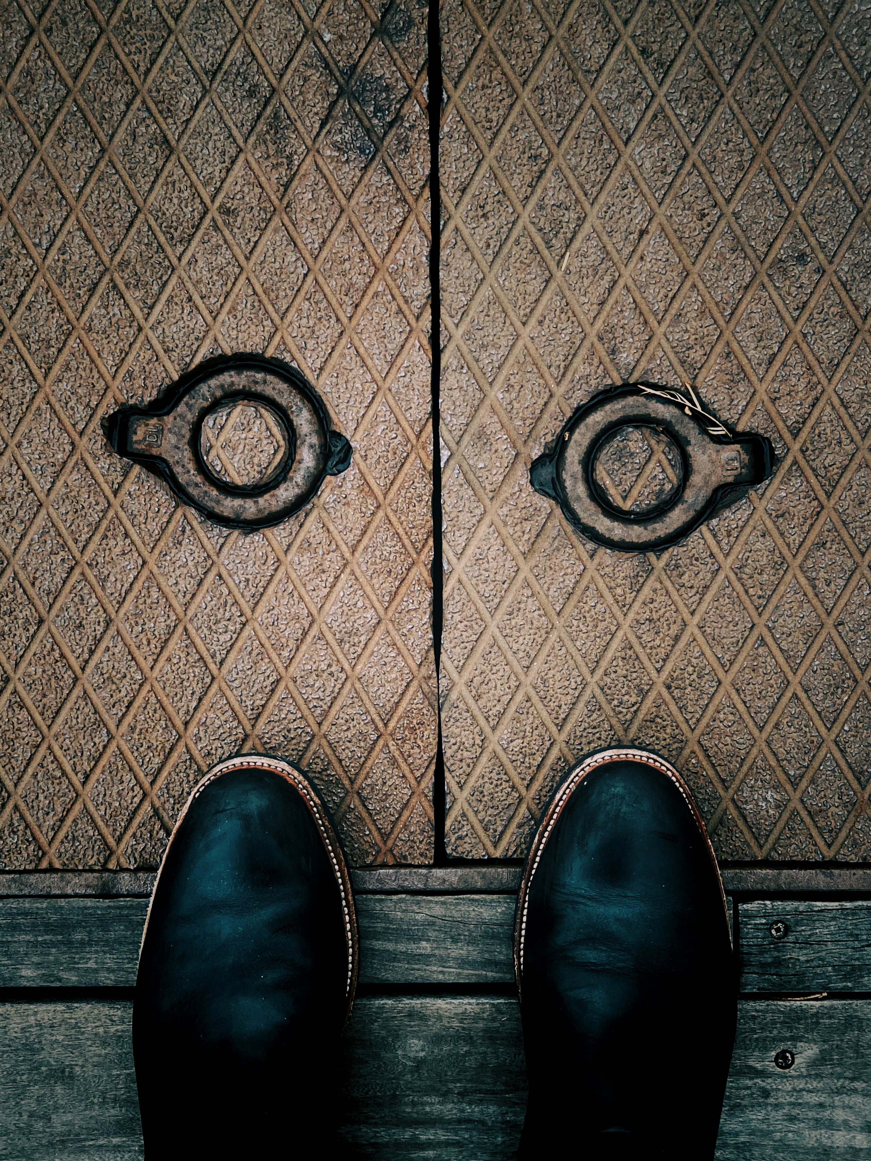 Symmetrical Grounding: Boots Framed by a Diamond-Grid Deck