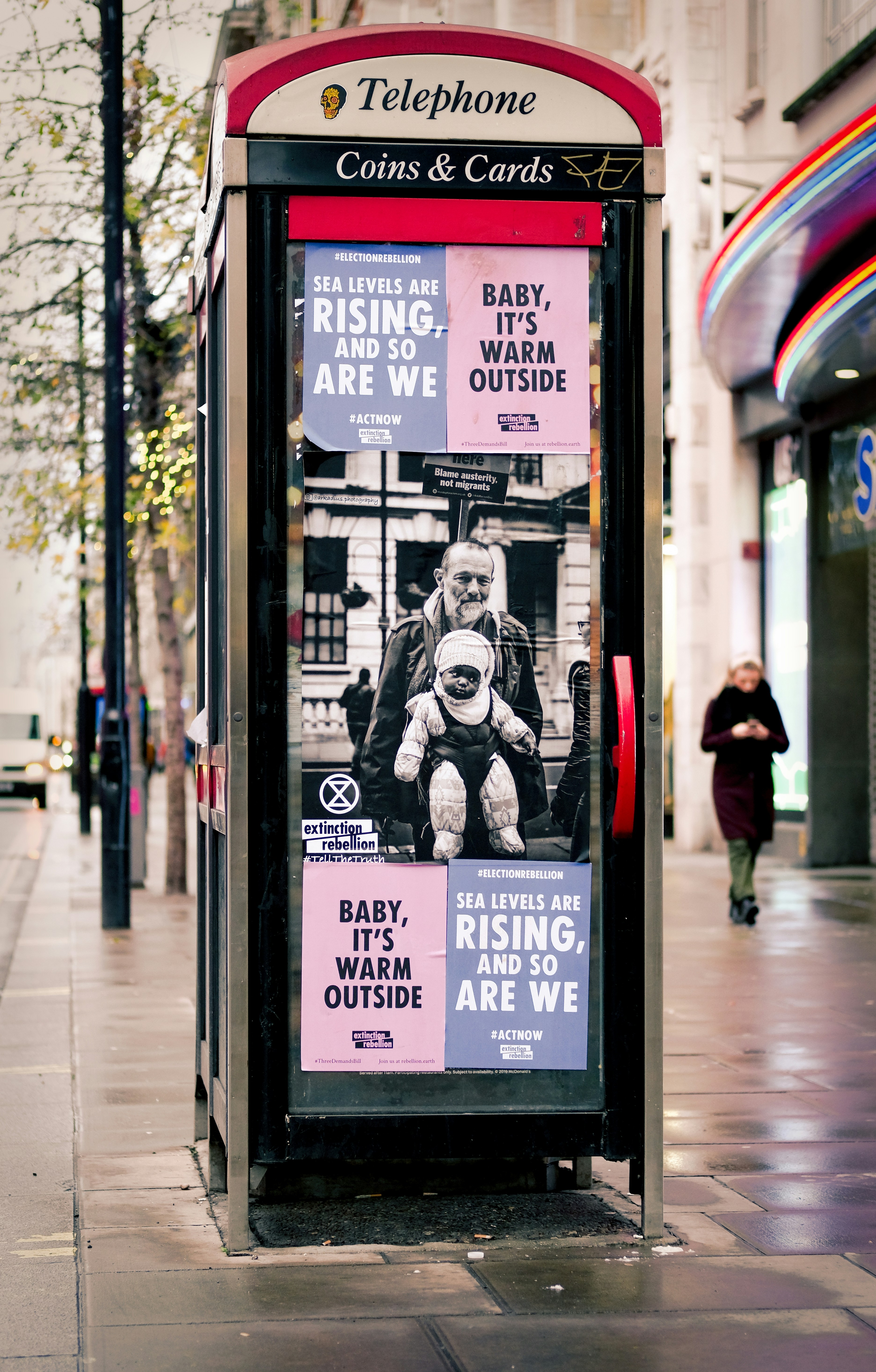 A public phone booth on a city street photo – Free Poster Image on Unsplash