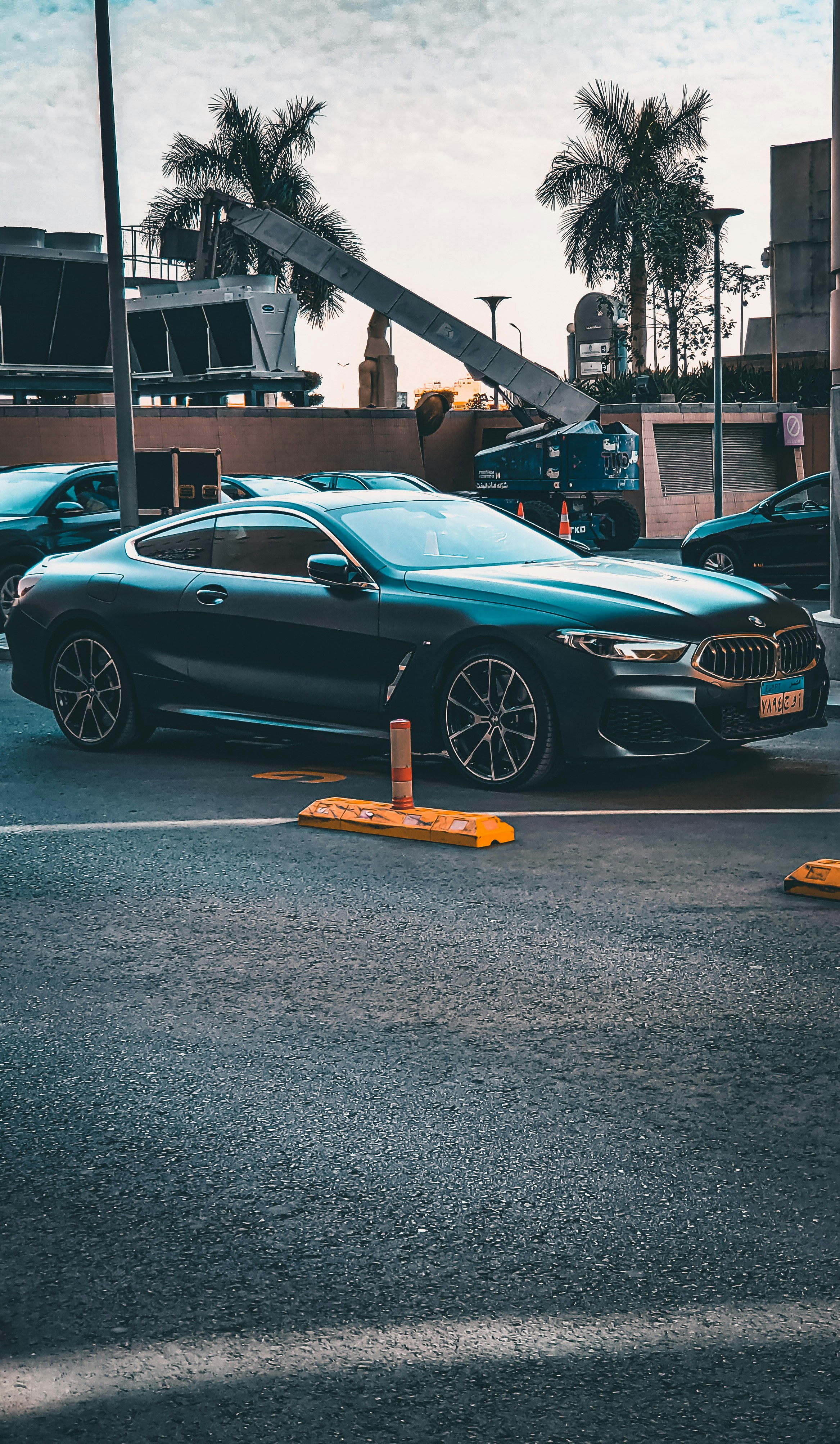 Low-angle Drive: A BMW M4 Stands Out in a Sunset-Lit Parking Lot