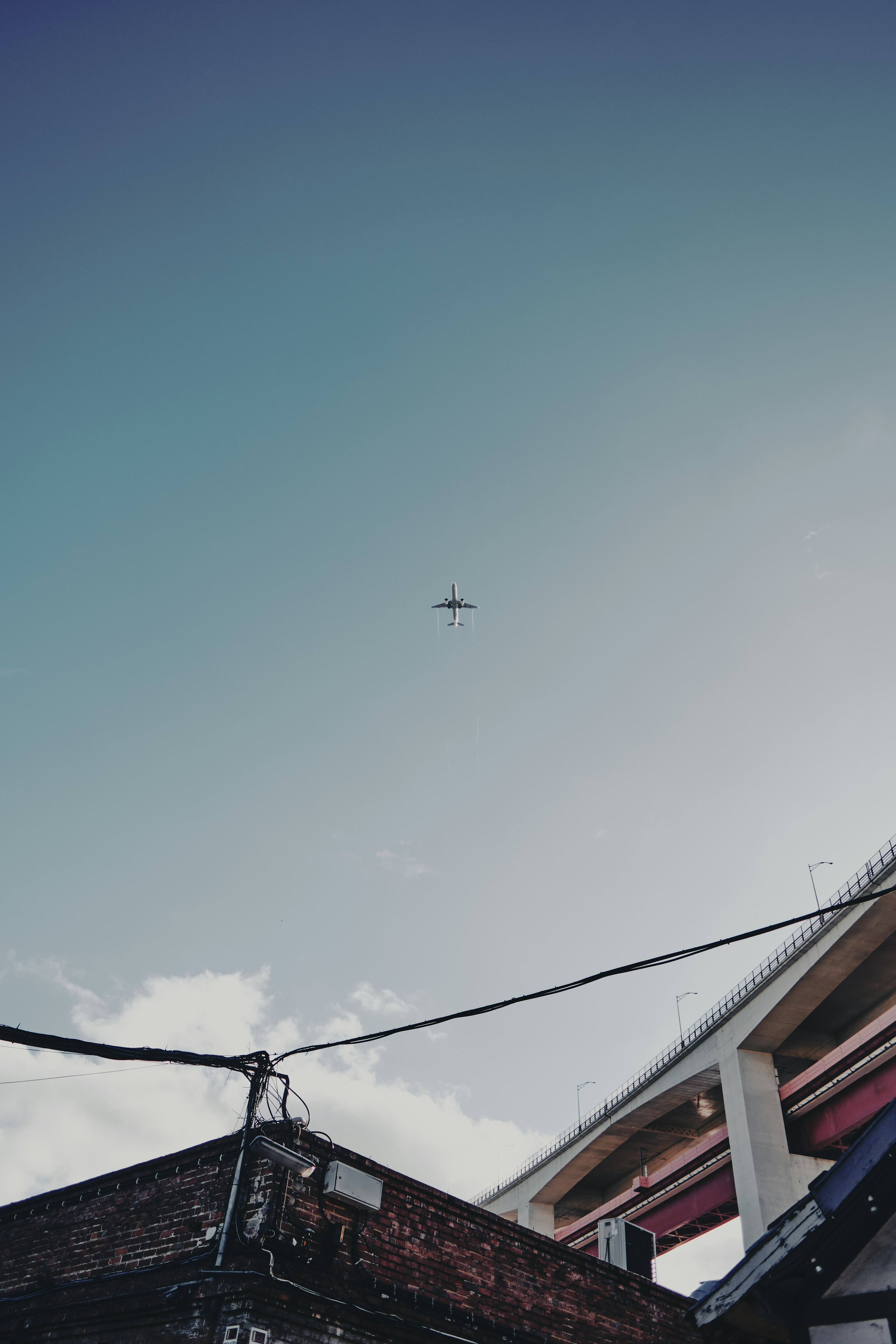 Jet Silhouette Over the Urban Span