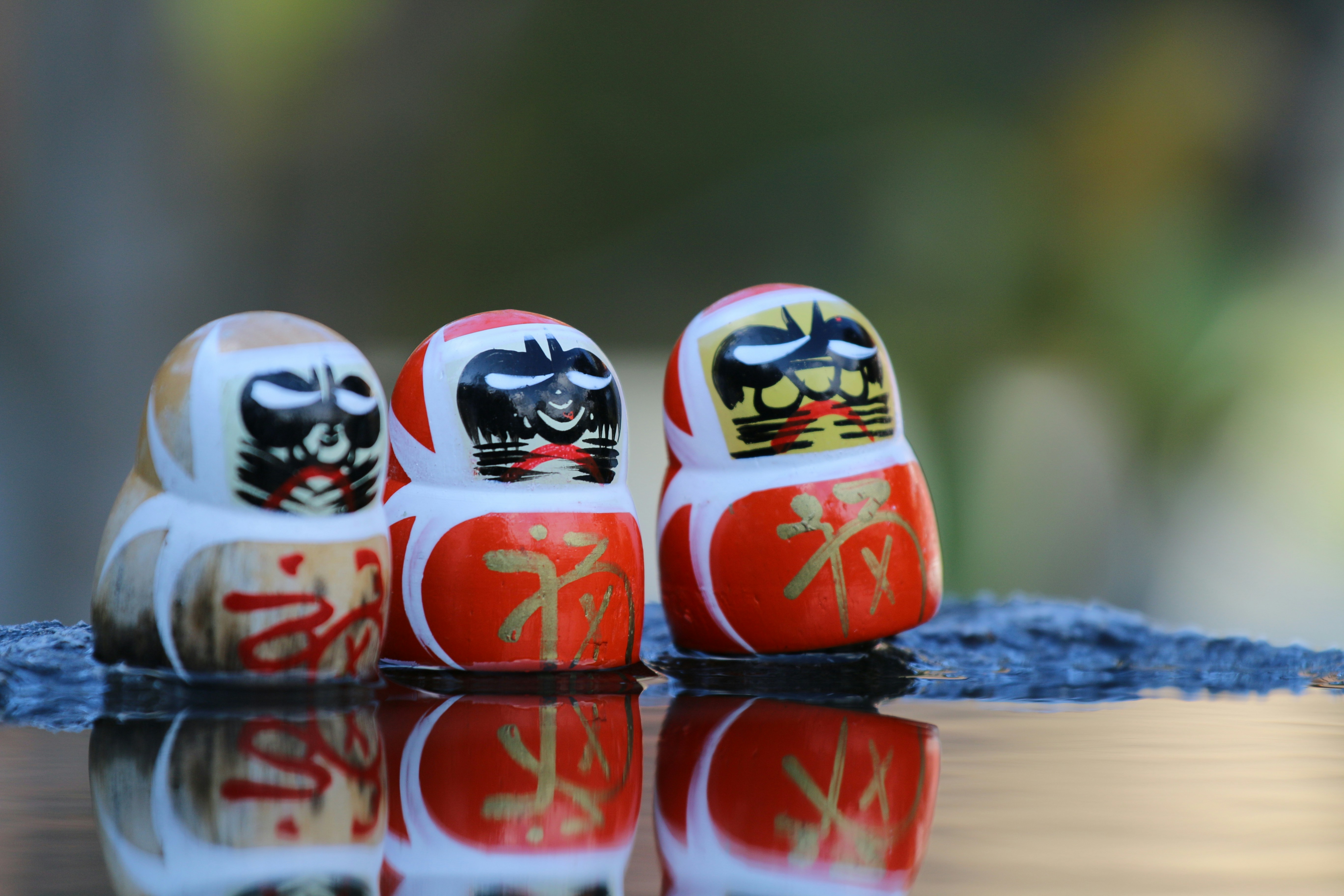 three white-and-red nesting dolls