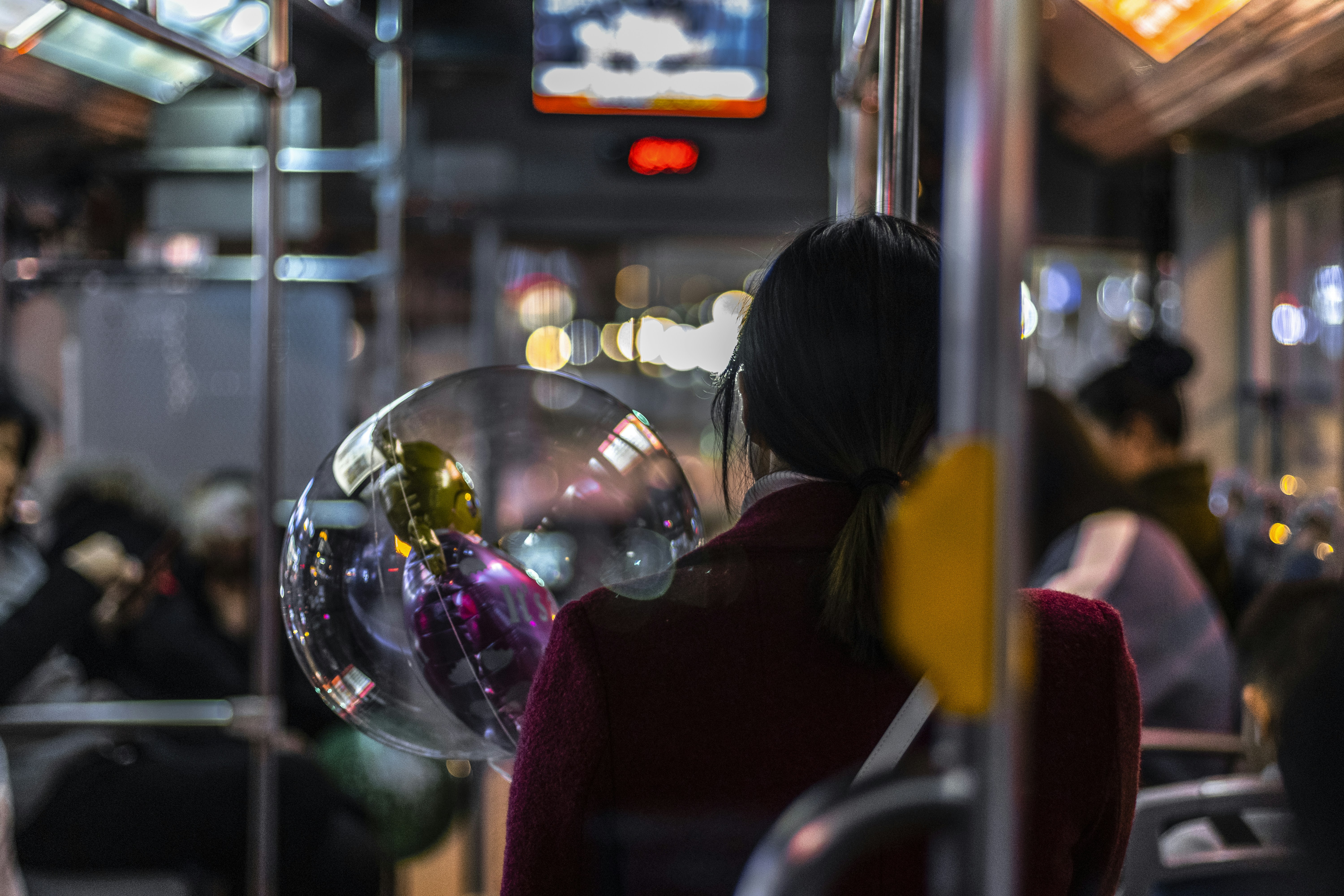 Bubble of Neon Reflections on a Night Bus