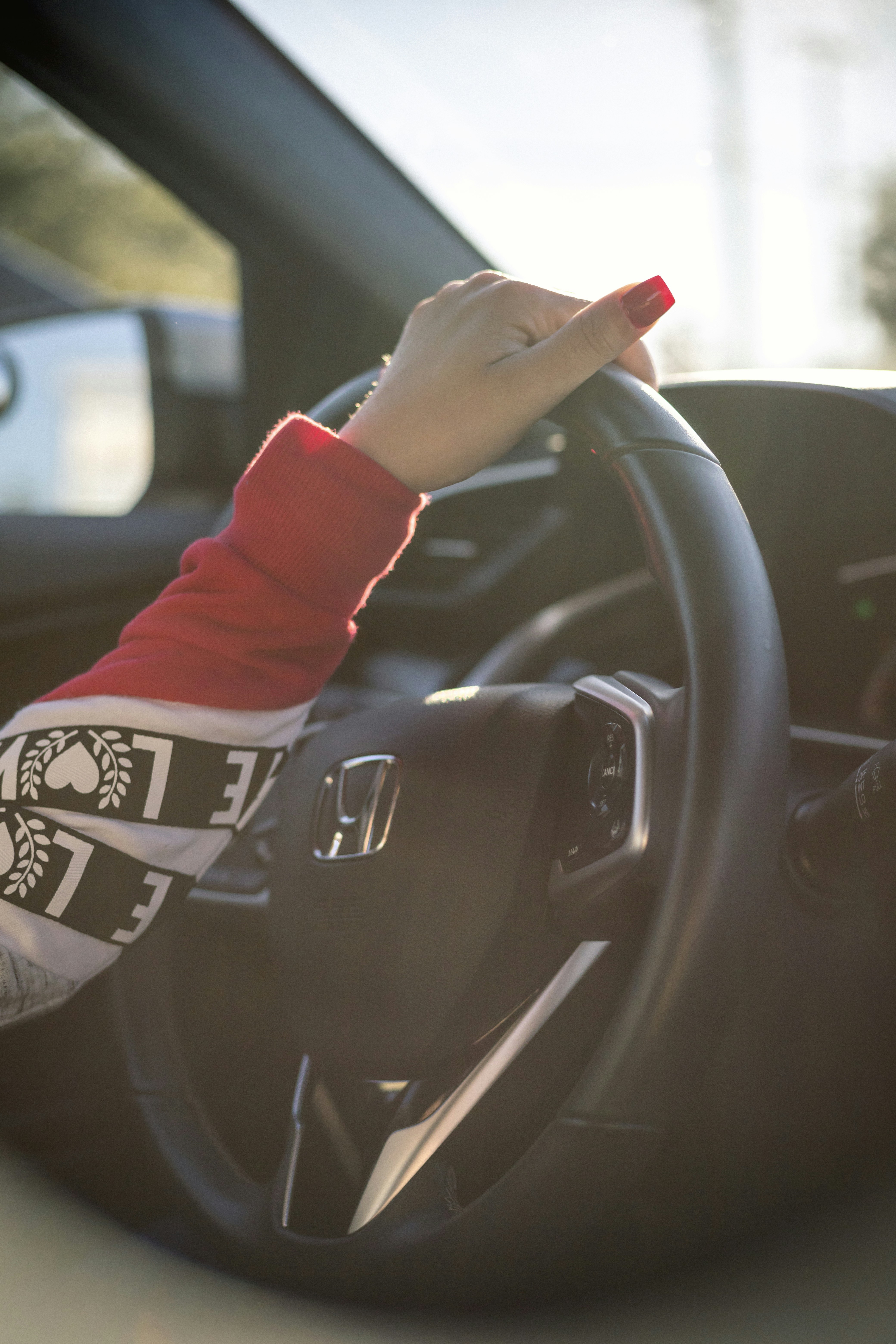 Hand on the Wheel: Red Sleeve in a Moment of Drive