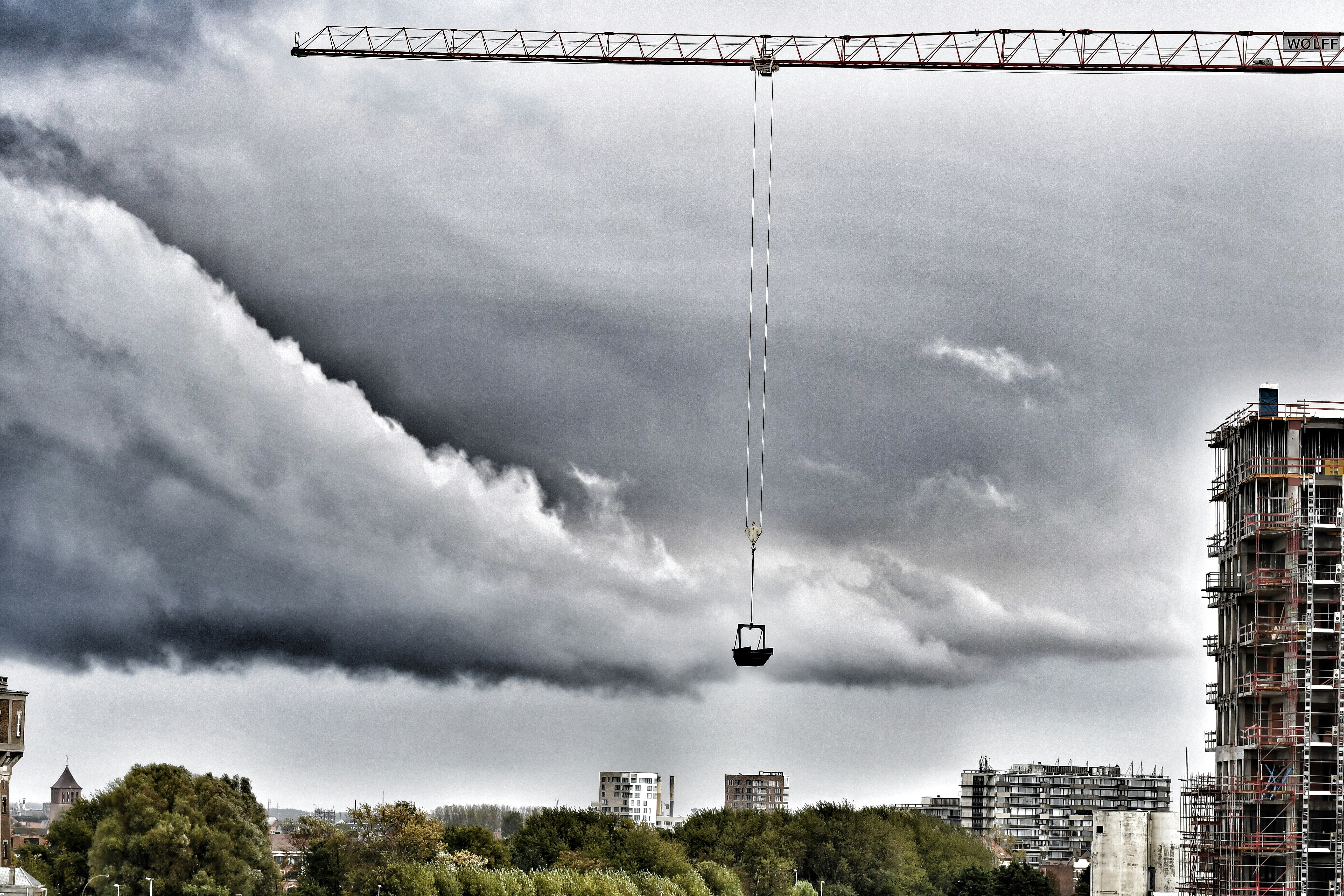Crane Lift Over Storm-Scarred Horizon