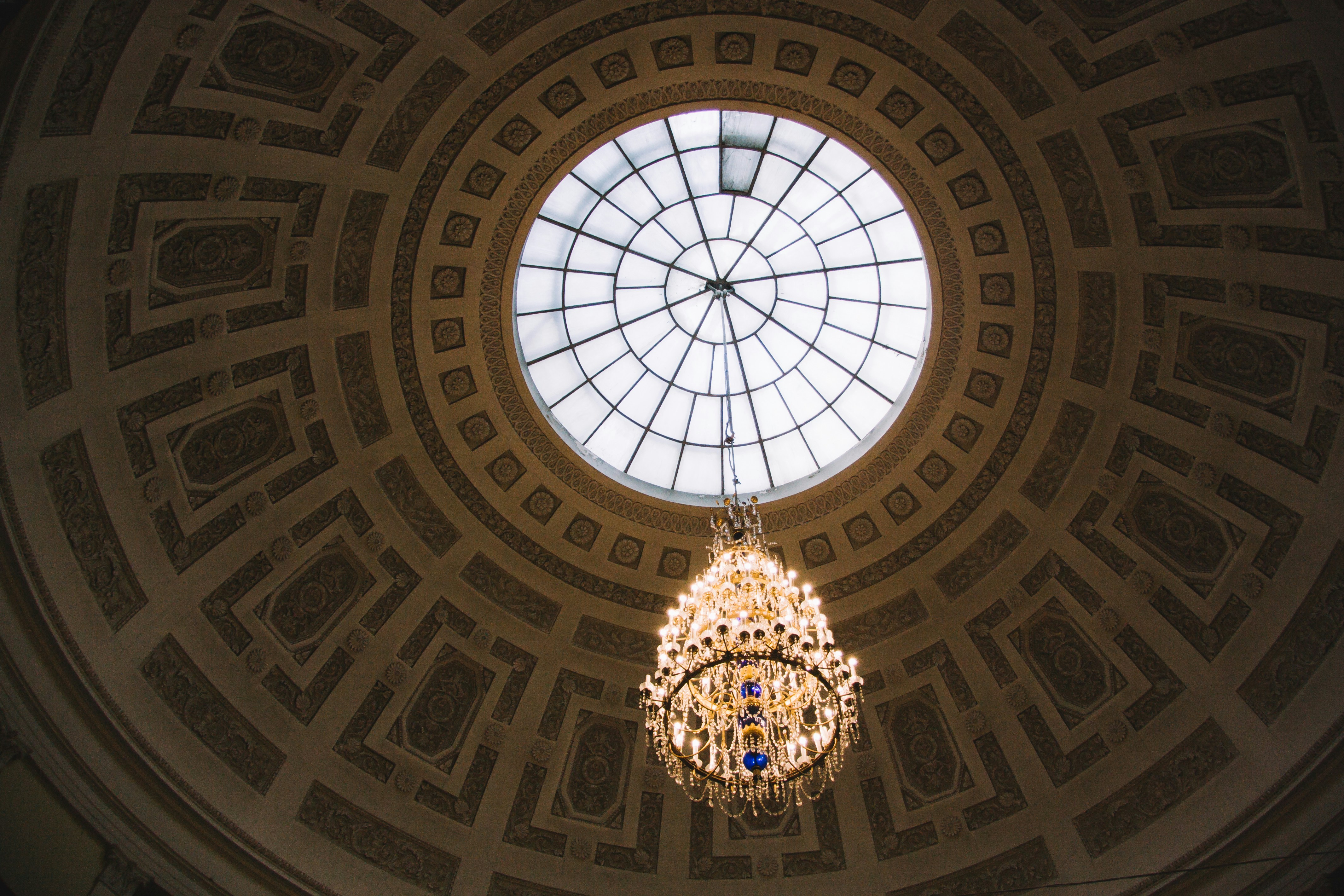 Chandelier Beneath a Circular Oculus: Crystal Luminance in a Marble Dome