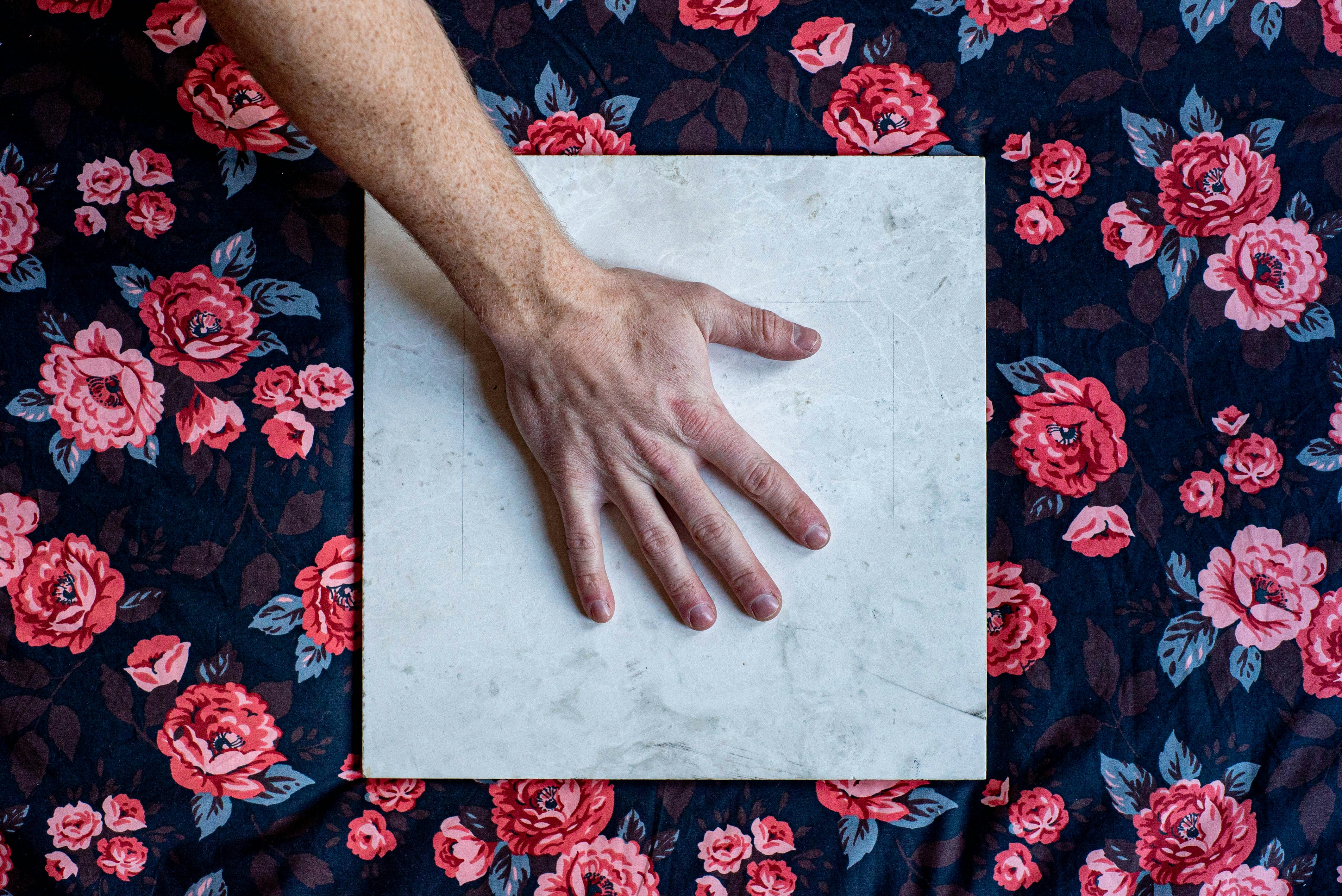 A person's hand resting on a piece of paper photo – Free Apparel Image ...