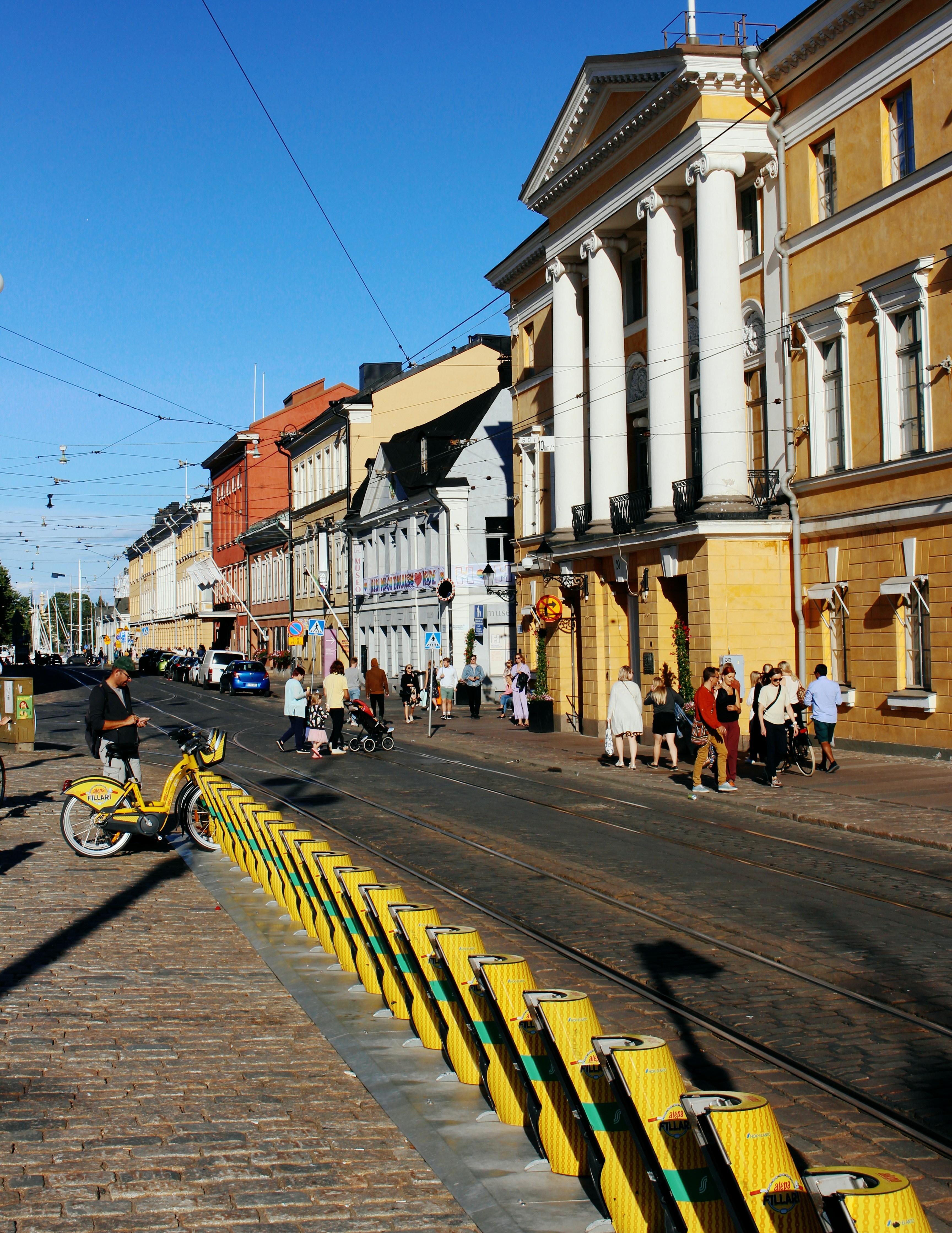 Tram Tracks and Golden Facade: A City Street in Motion