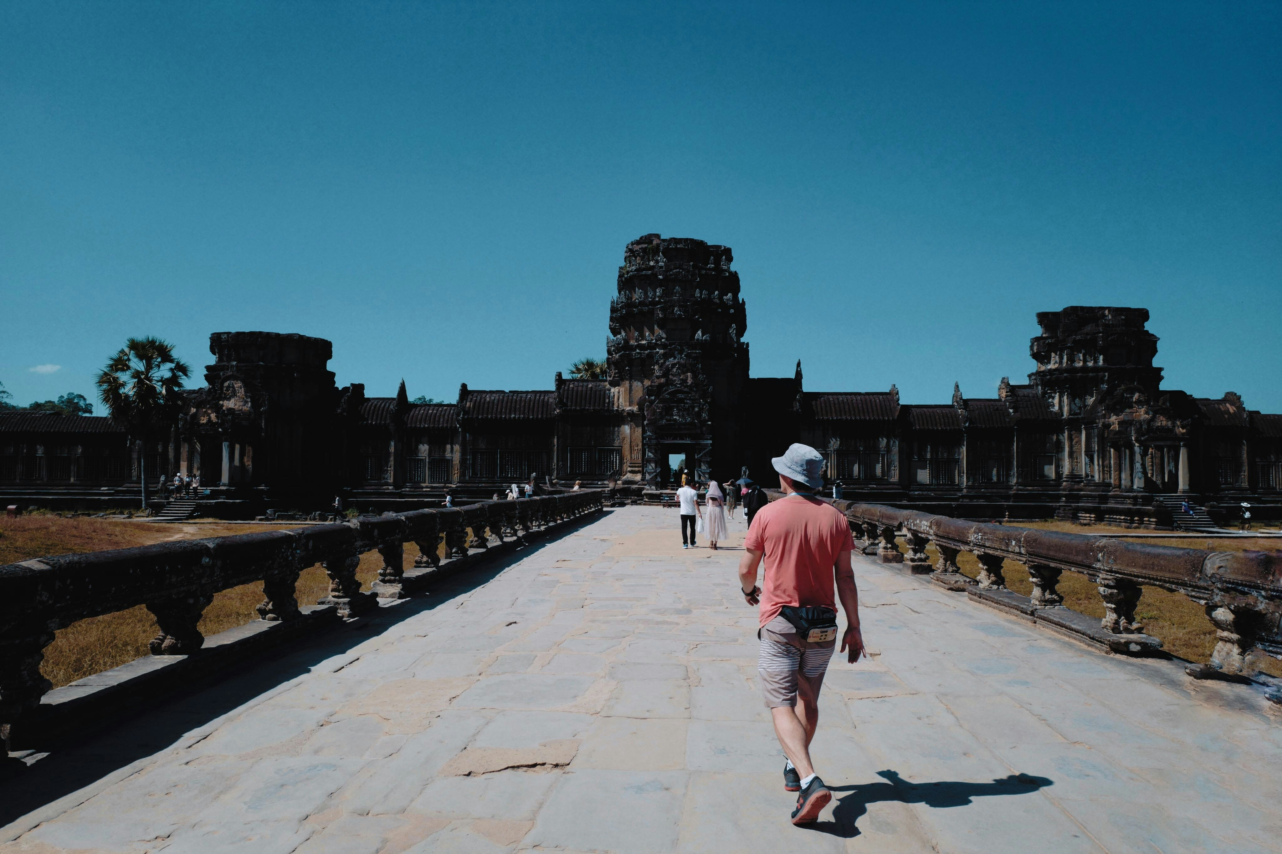 Traveler in a Stone Corridor Towards Ancient Towers