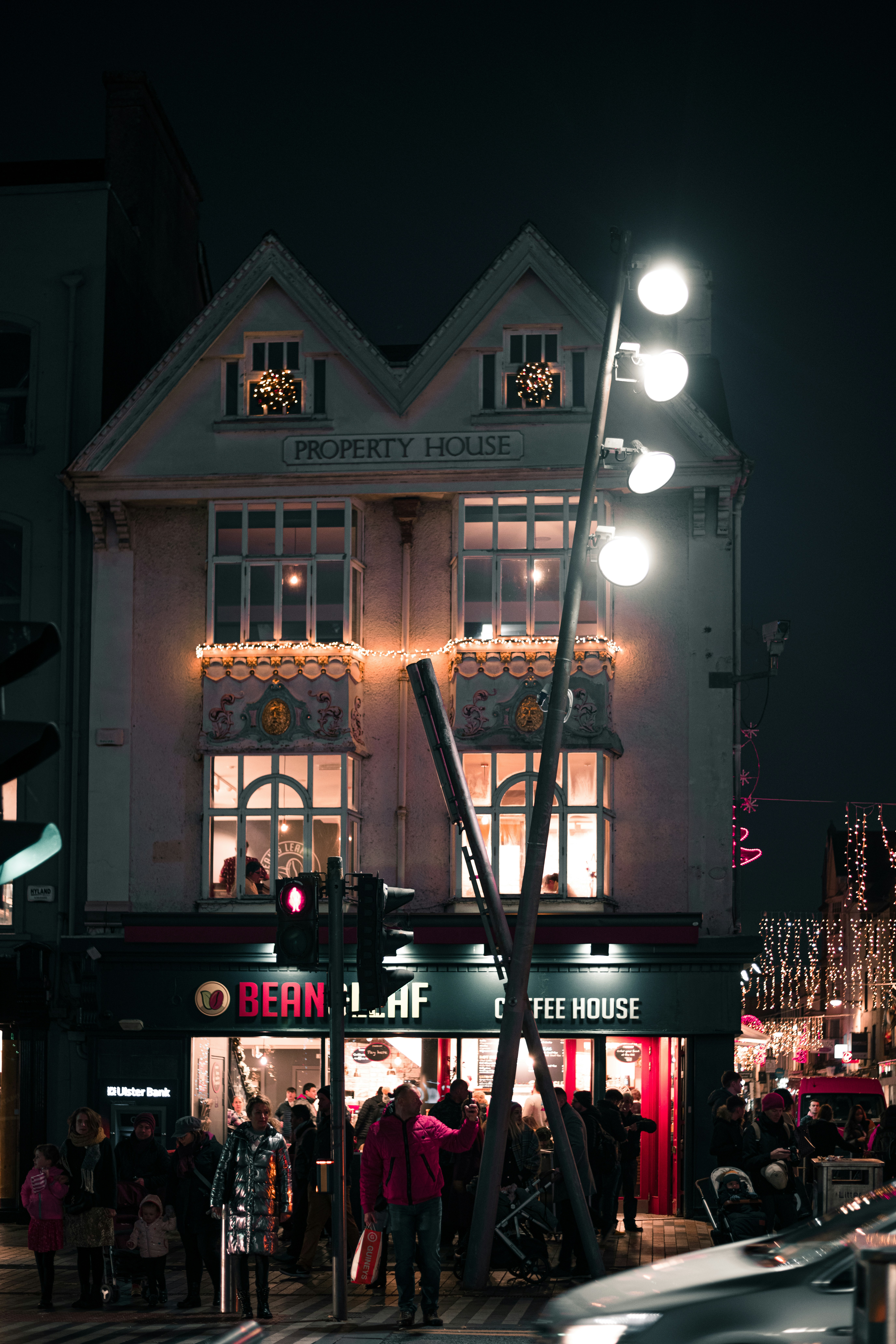Festive Glow Under a Leaning Streetlight at a Victorian Coffee House