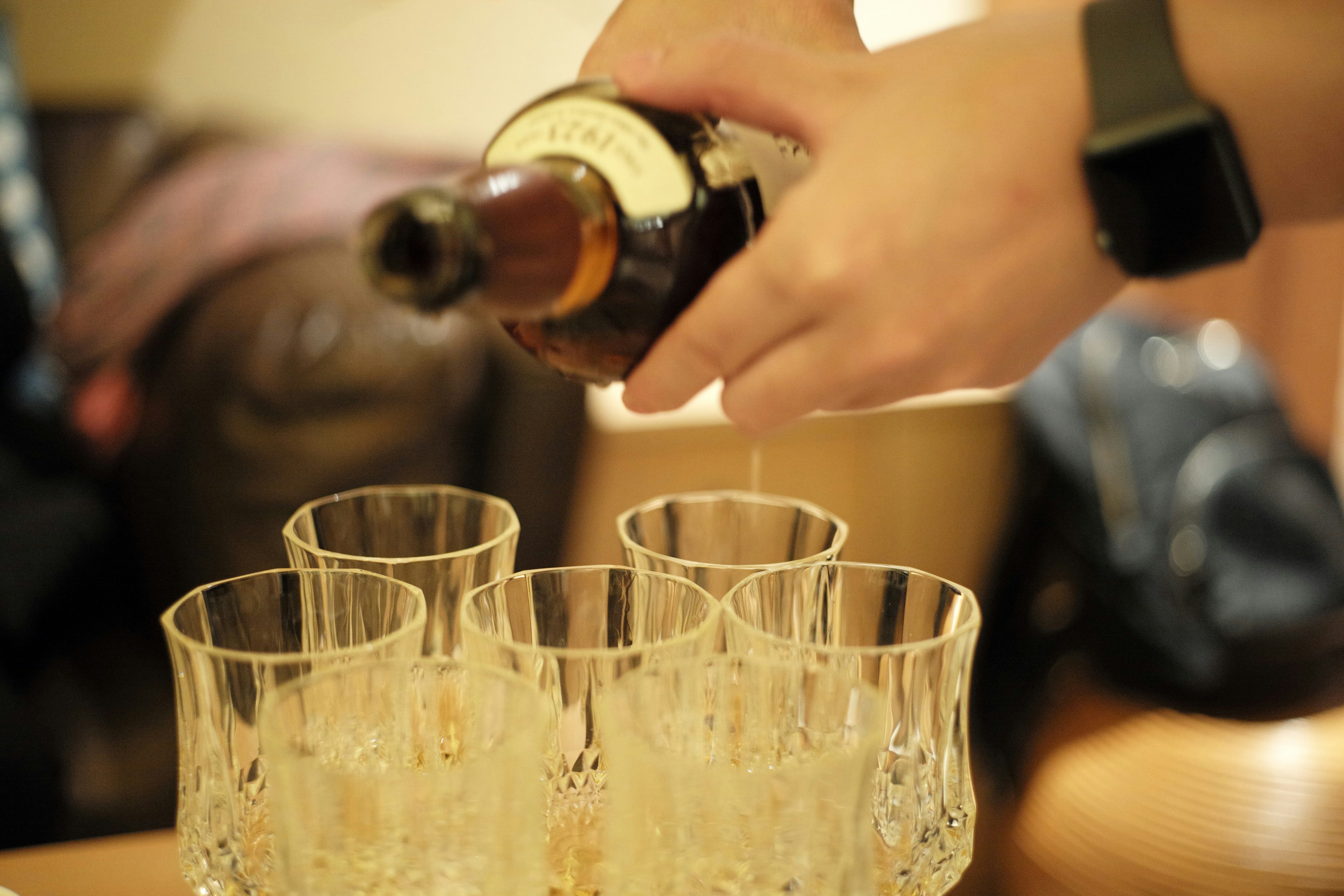 Gesture of Celebration: Champagne Streams Into Crystal Flutes