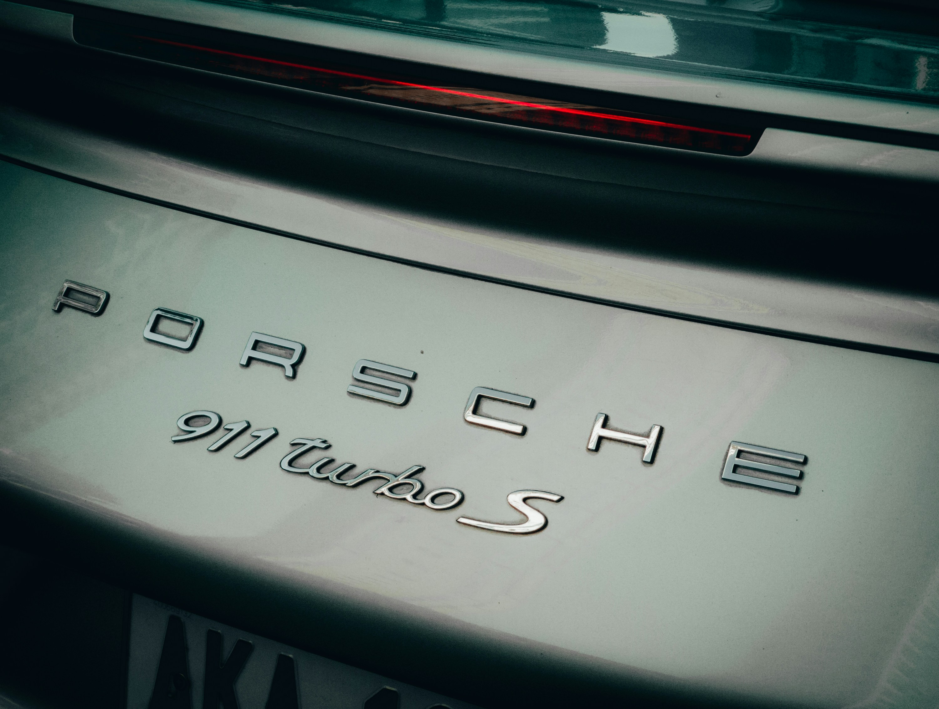 Chrome on Steel: Close-Up of Porsche 911 Turbo S Emblem