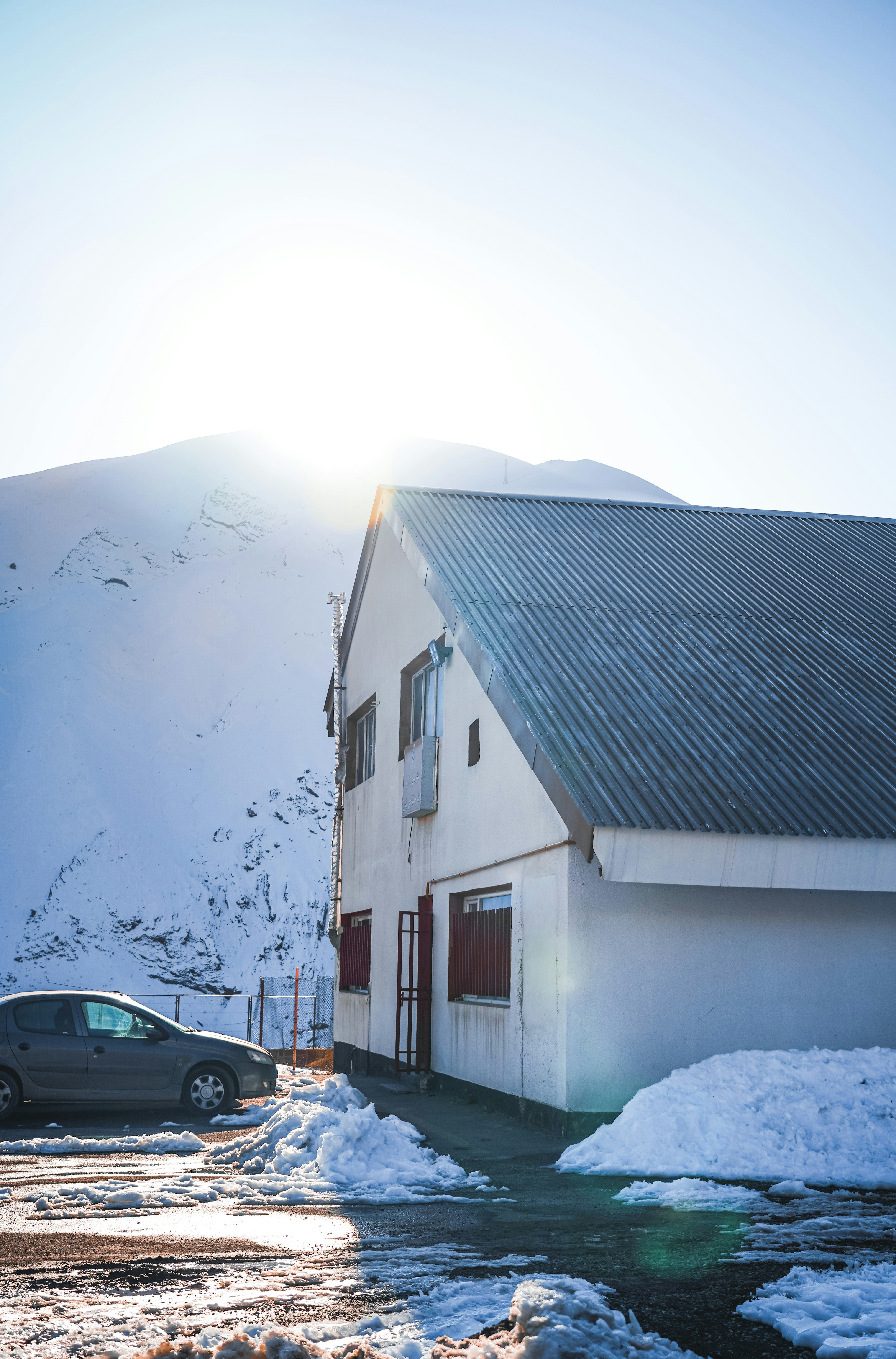 Alpine Chalet Bathed in Morning Light Over a Snow-Dusted Peak