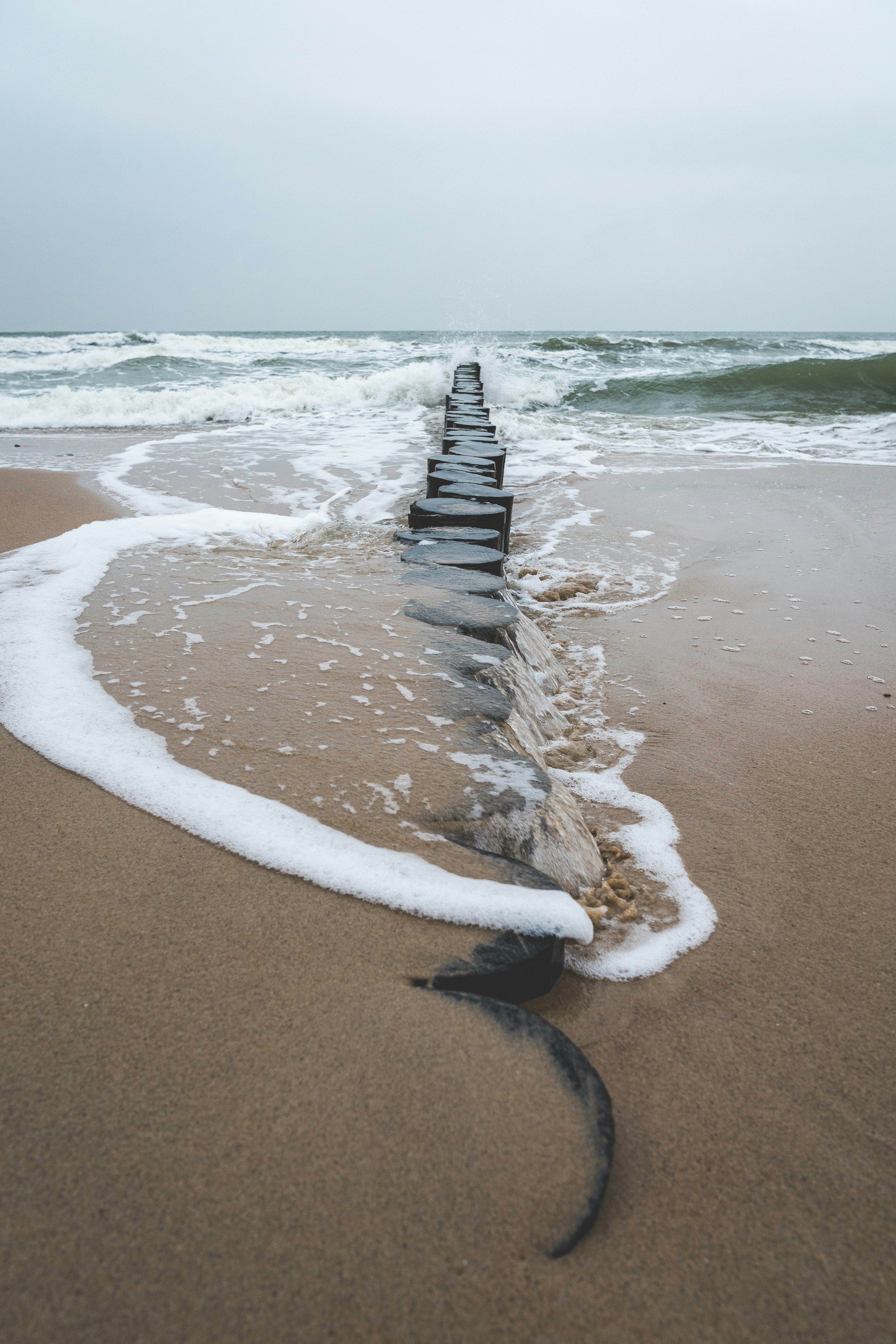 The Stone Spine: A Seaside Jetty Reaching the Misty Horizon