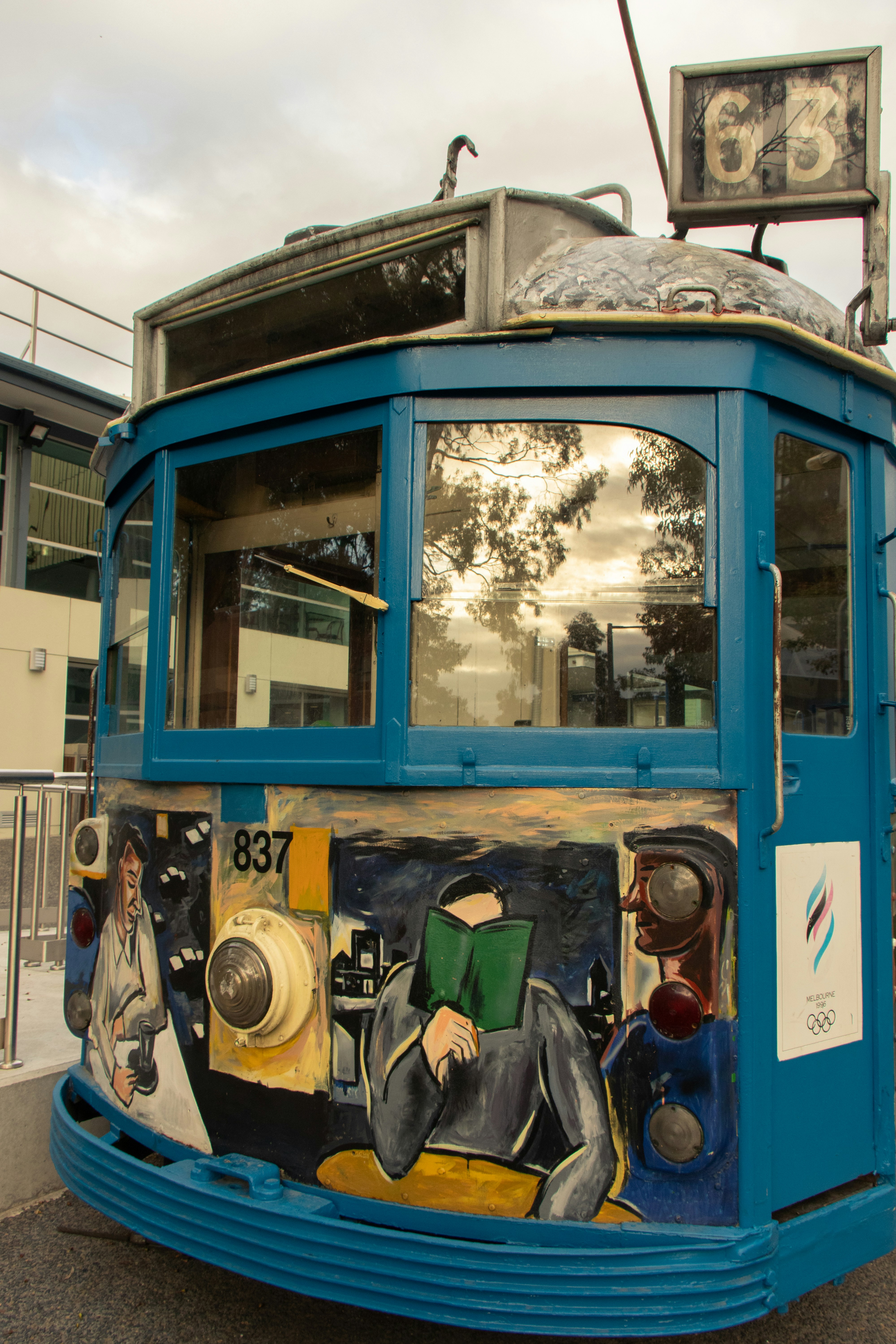 The Reading Tram: A Blue Streetcar Wrapped in a Mural of City Dwellers