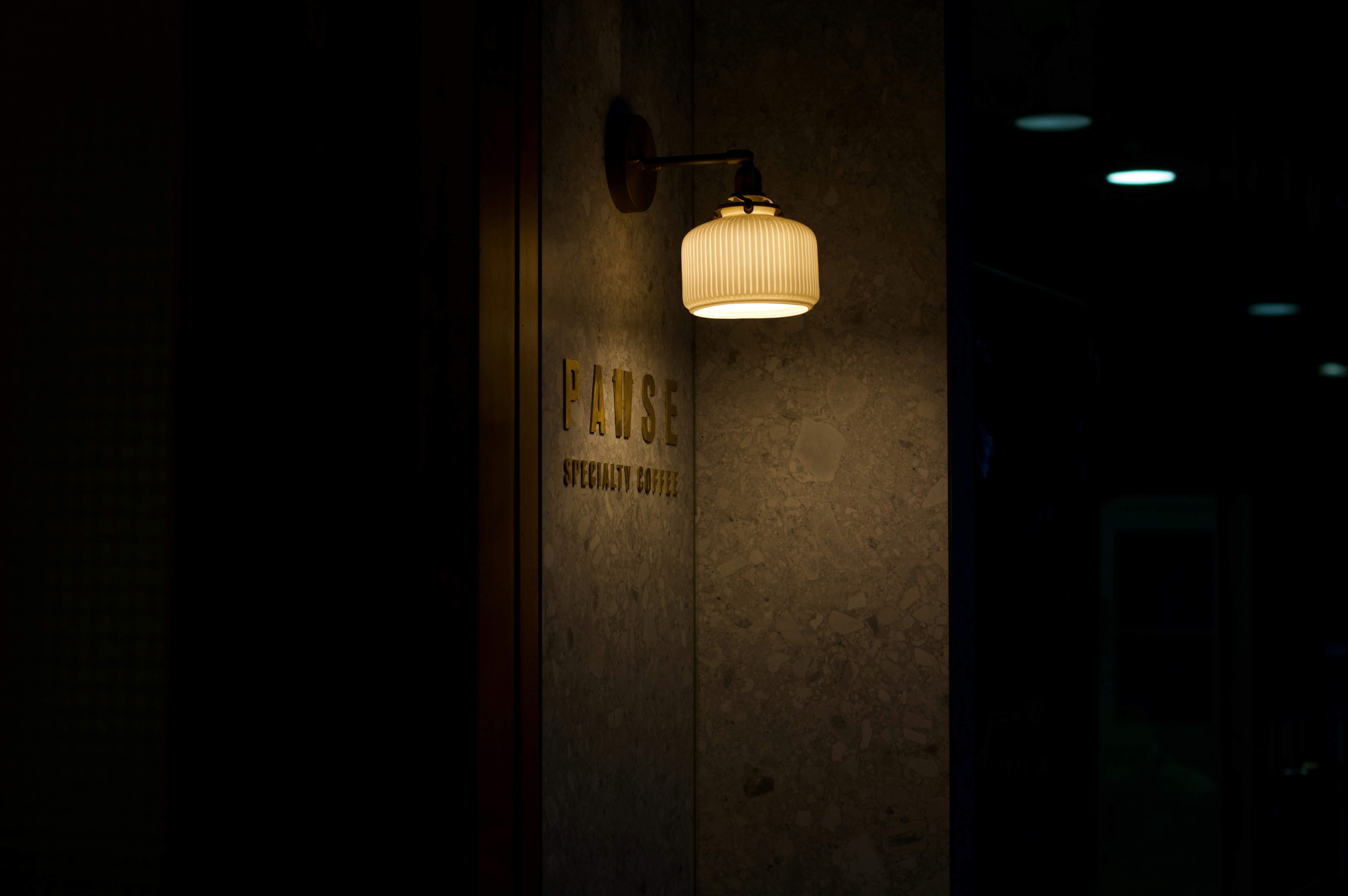 Warm sconce casting a soft glow on a dimly lit wall, creating an inviting ambiance.