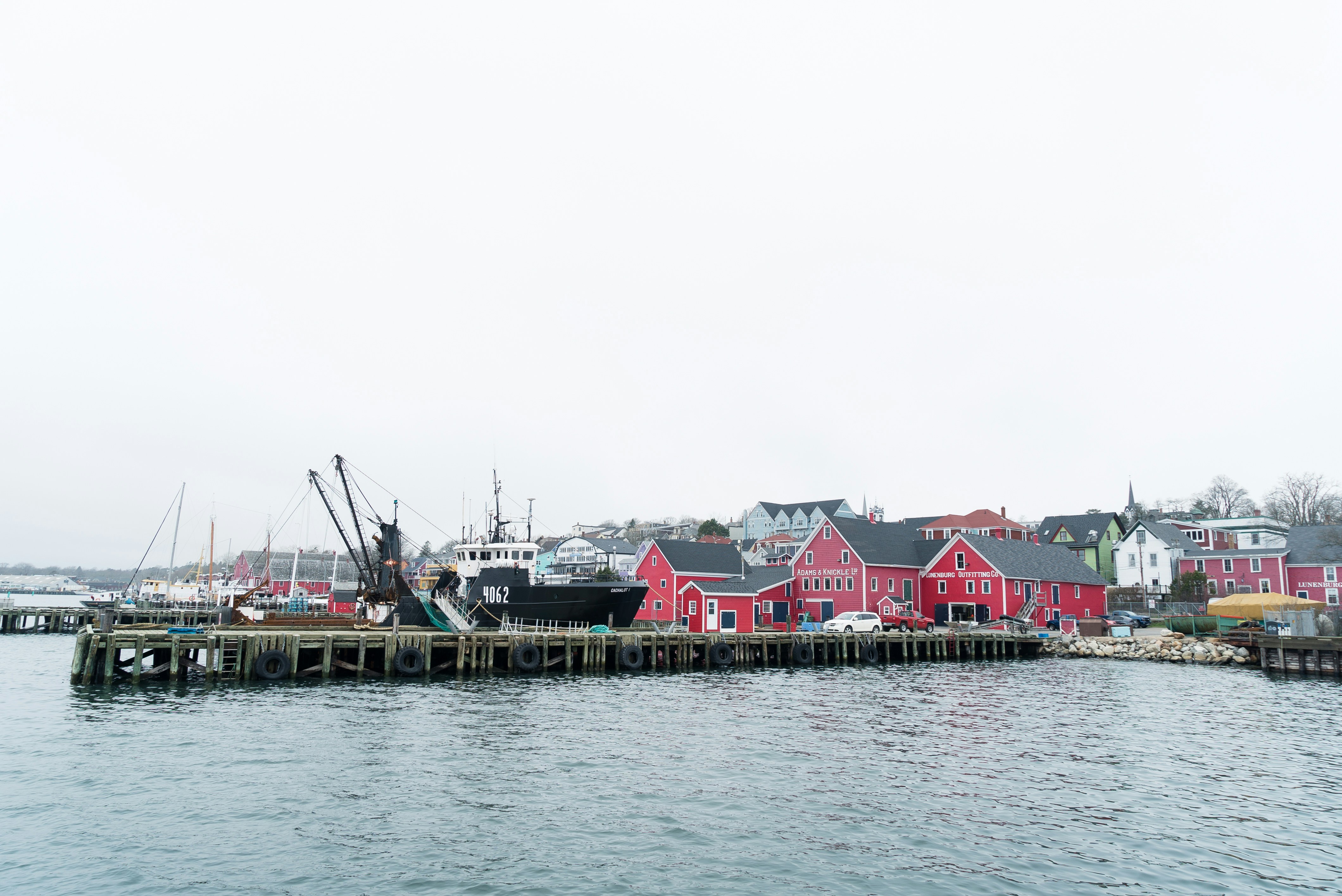 Pierfront with Red Barns and Fishing Fleet