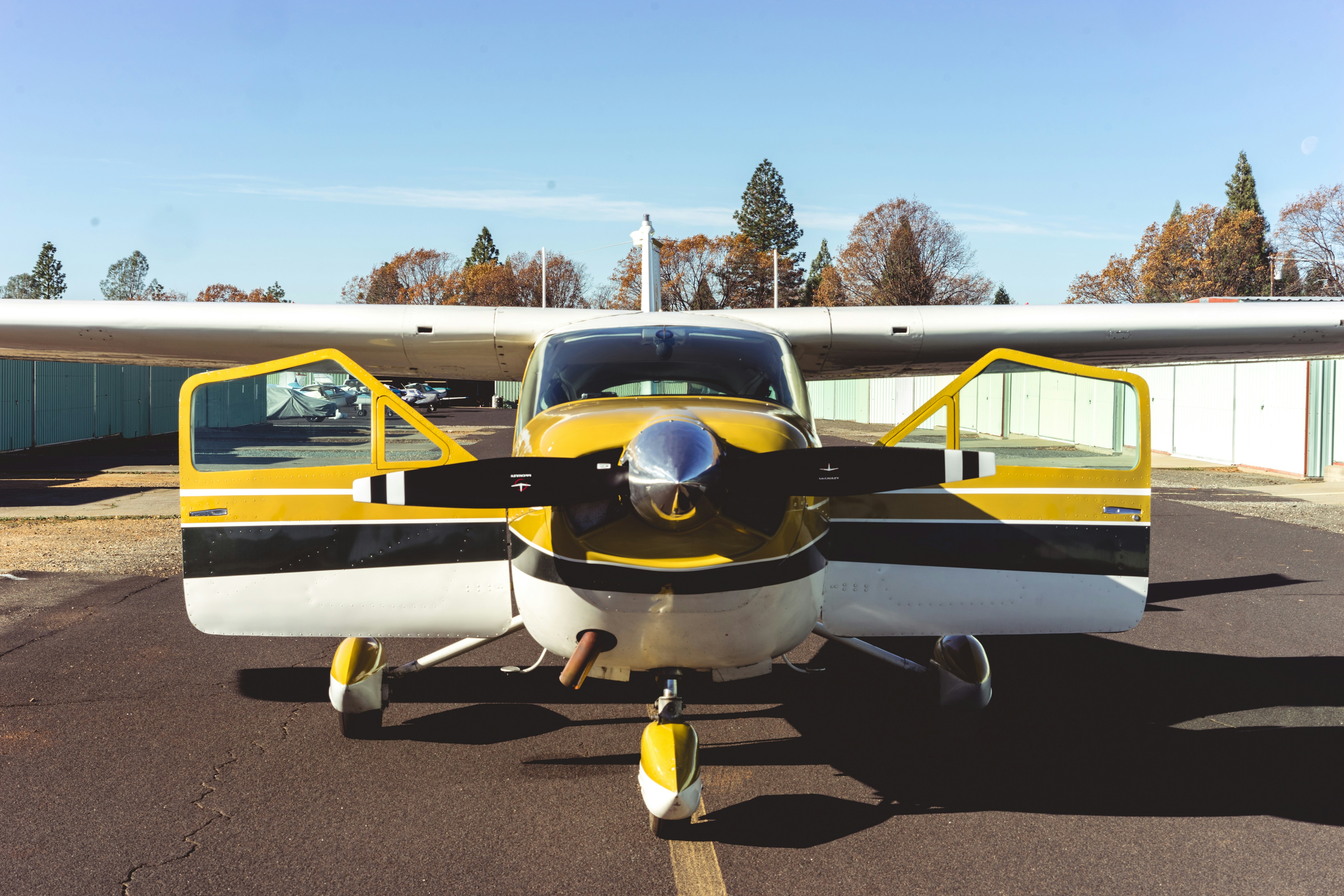 Front View of a Bright Yellow Trainer Aircraft with Open Doors