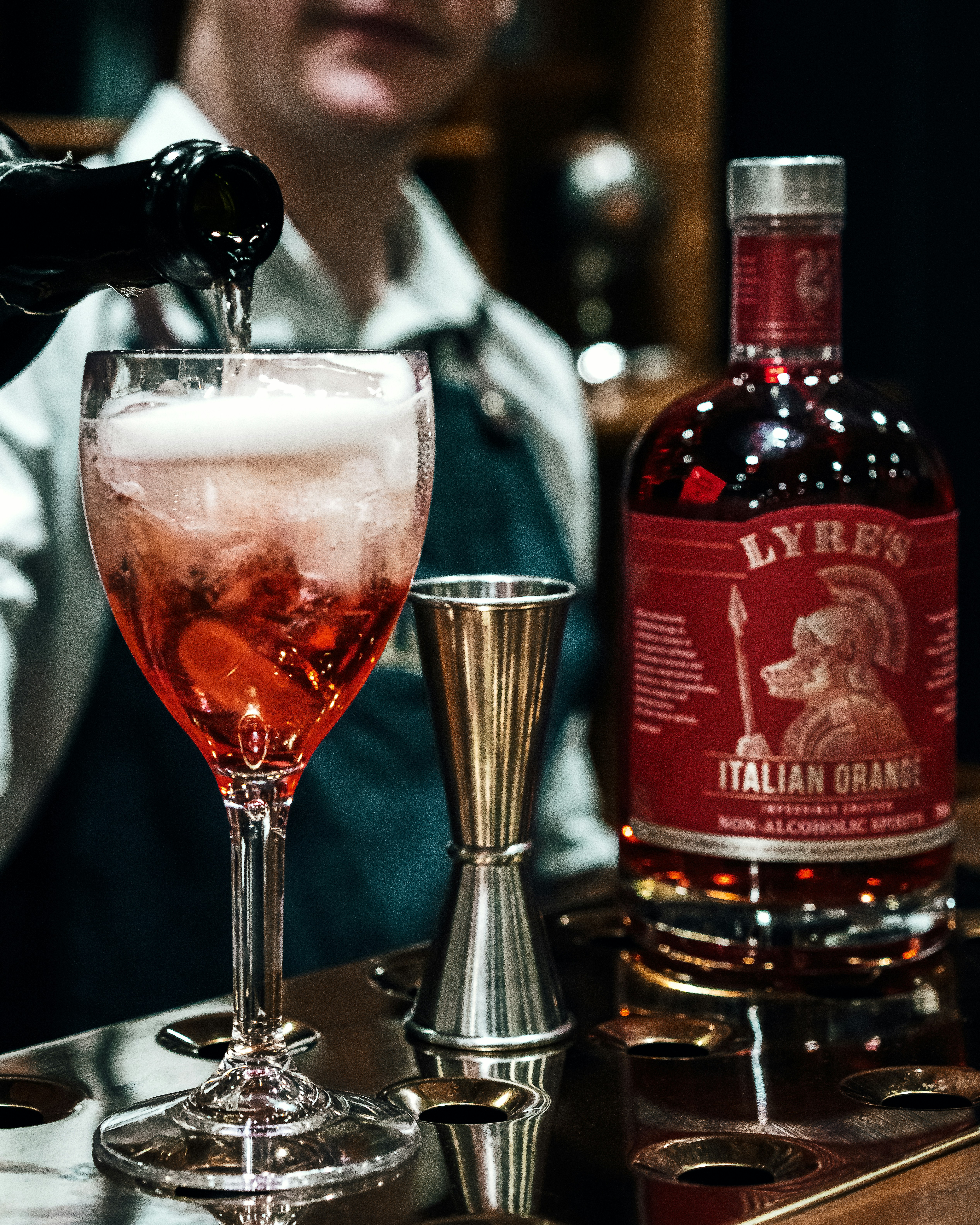 Pouring Crimson Clarity: A Bar Scene with Lyre’s Italian Orange