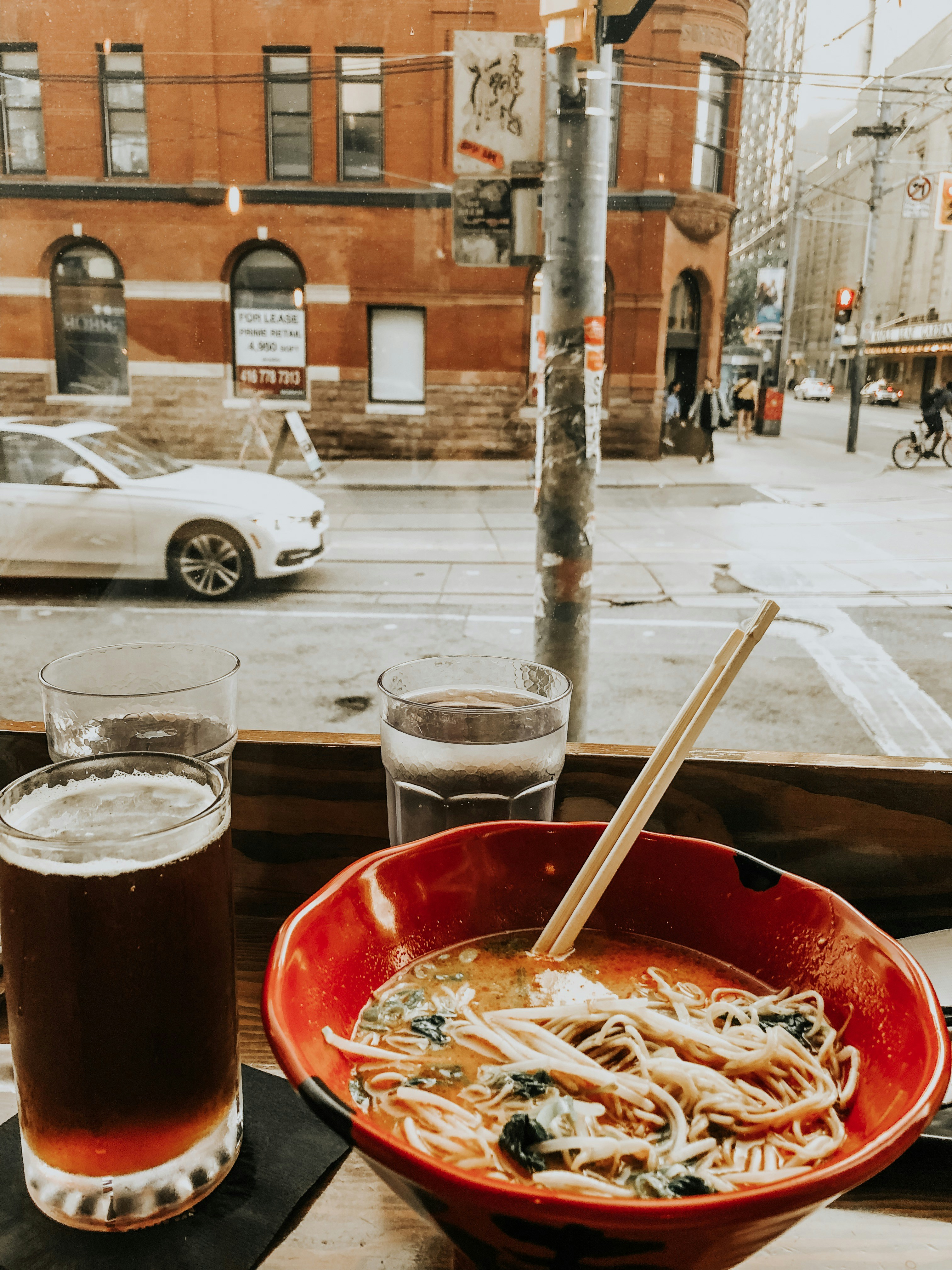 Urban Noodle Window: A Red Bowl in Focus