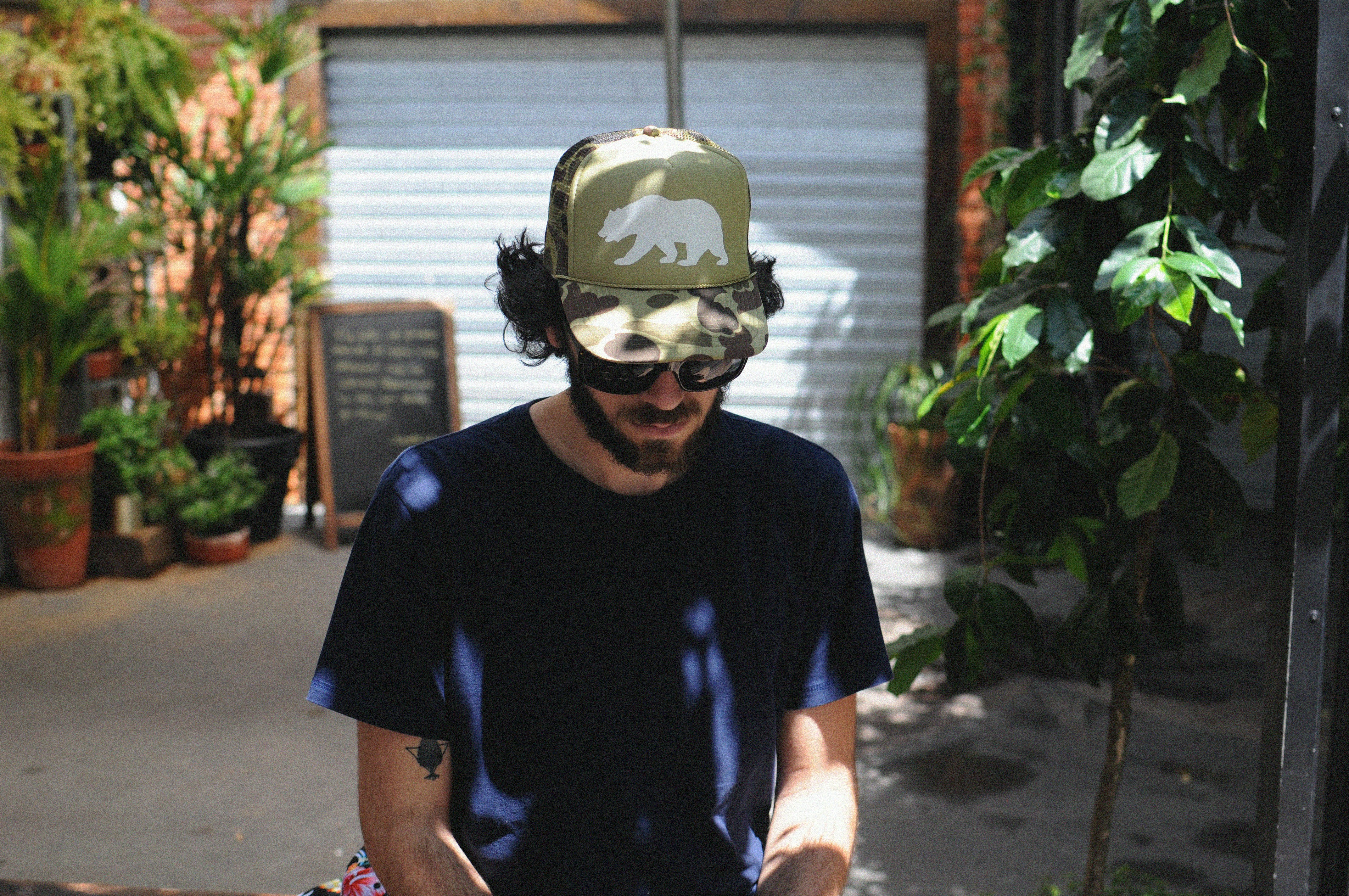 Urban Quiet: Portrait Under a Camouflage Cap