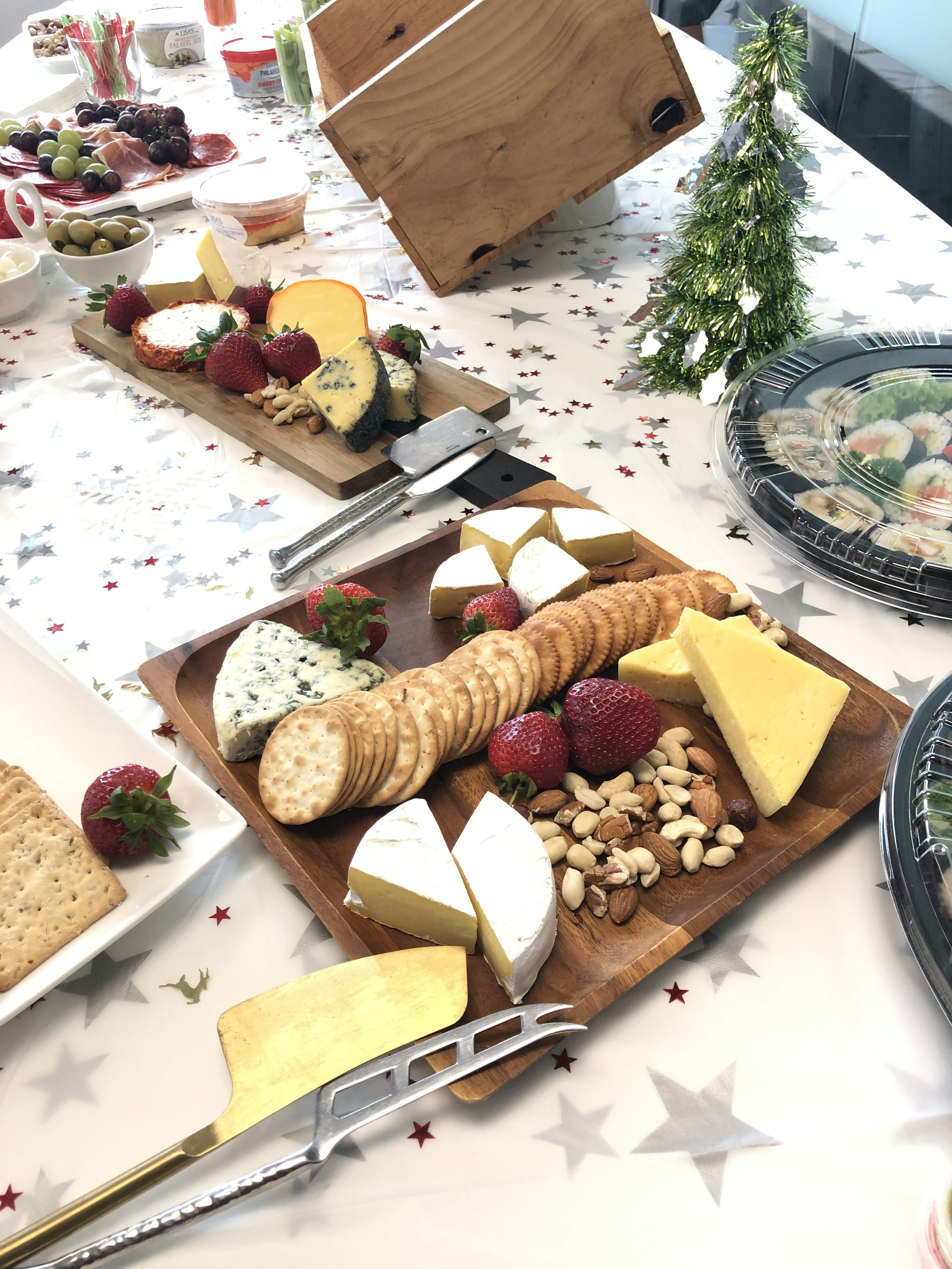 Cheese Charcuterie Board alight with berries and crackers on a festive table