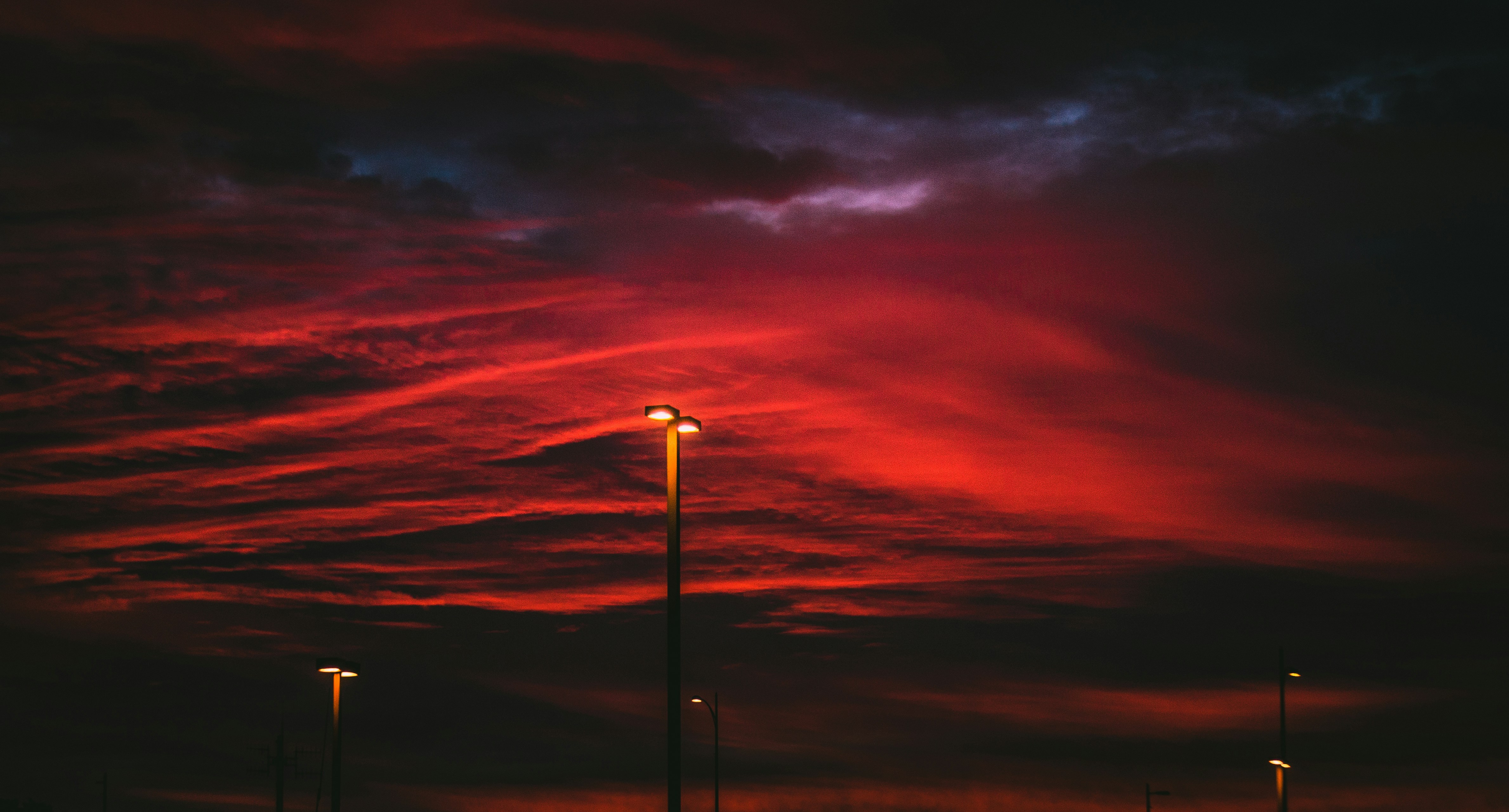 Crimson Hour Over Quiet Streetlights