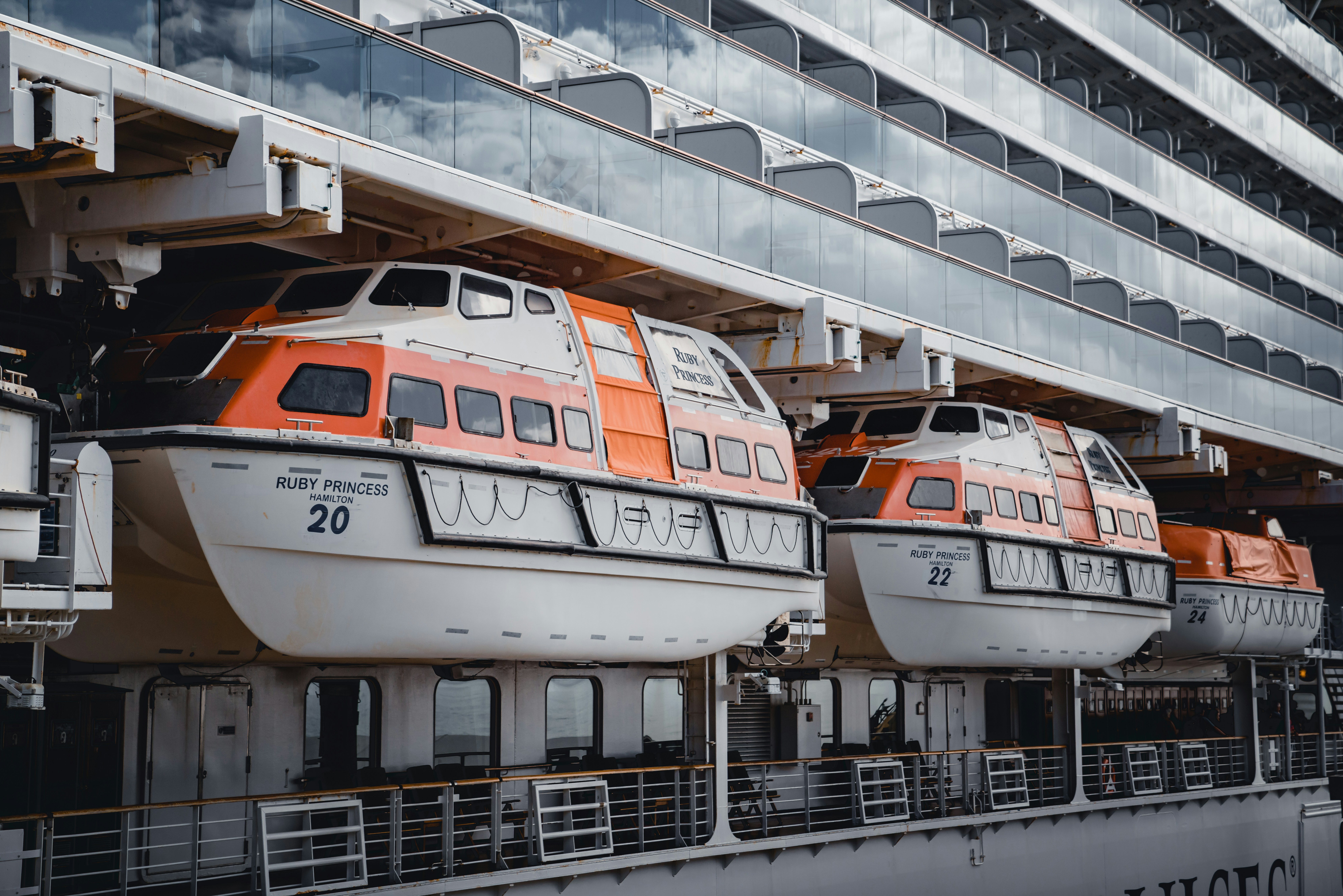 Three white and orange boats inside a ship photo – Free Building Image ...