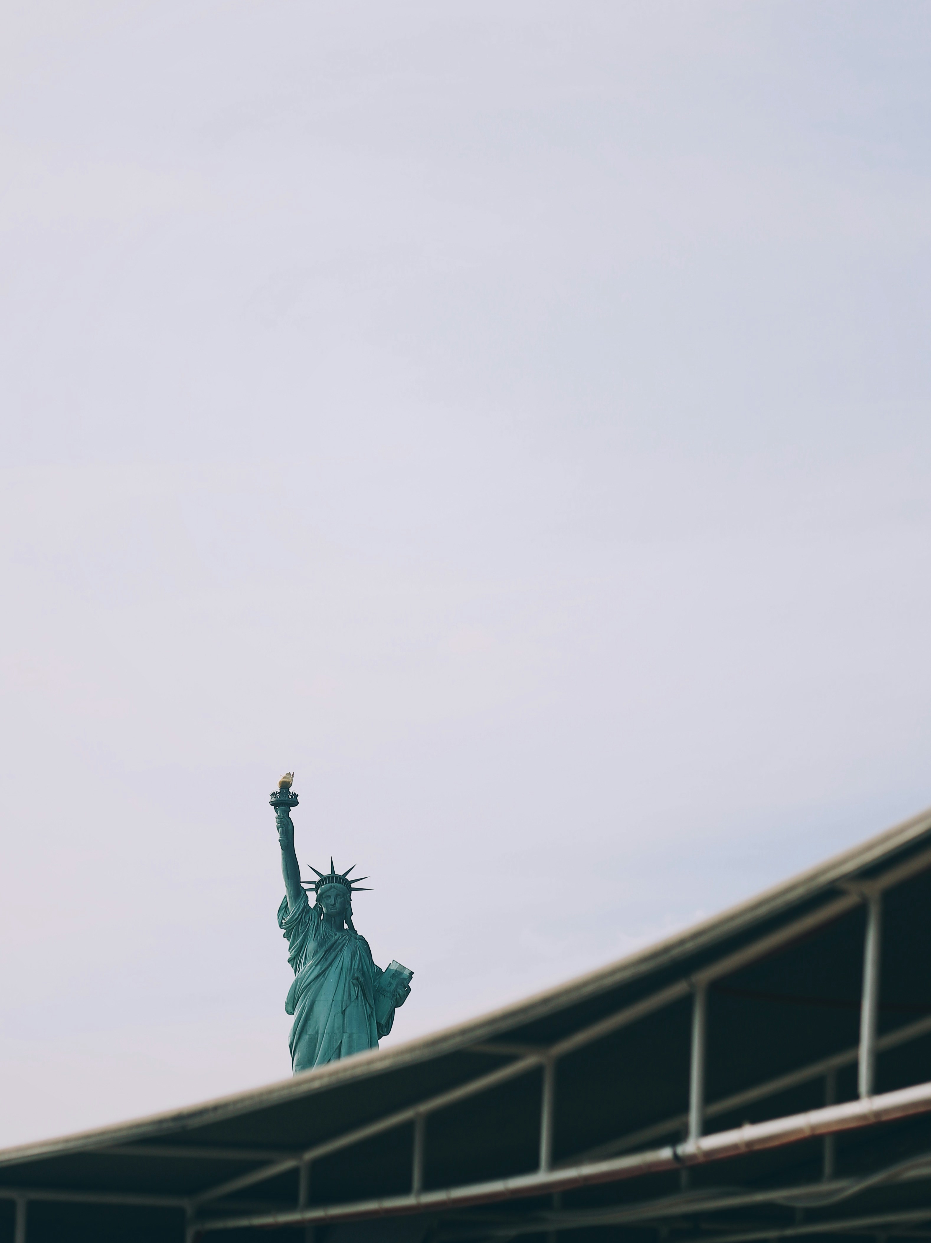 Torch Over the Curve: Liberty Emerges Beyond the Roofline