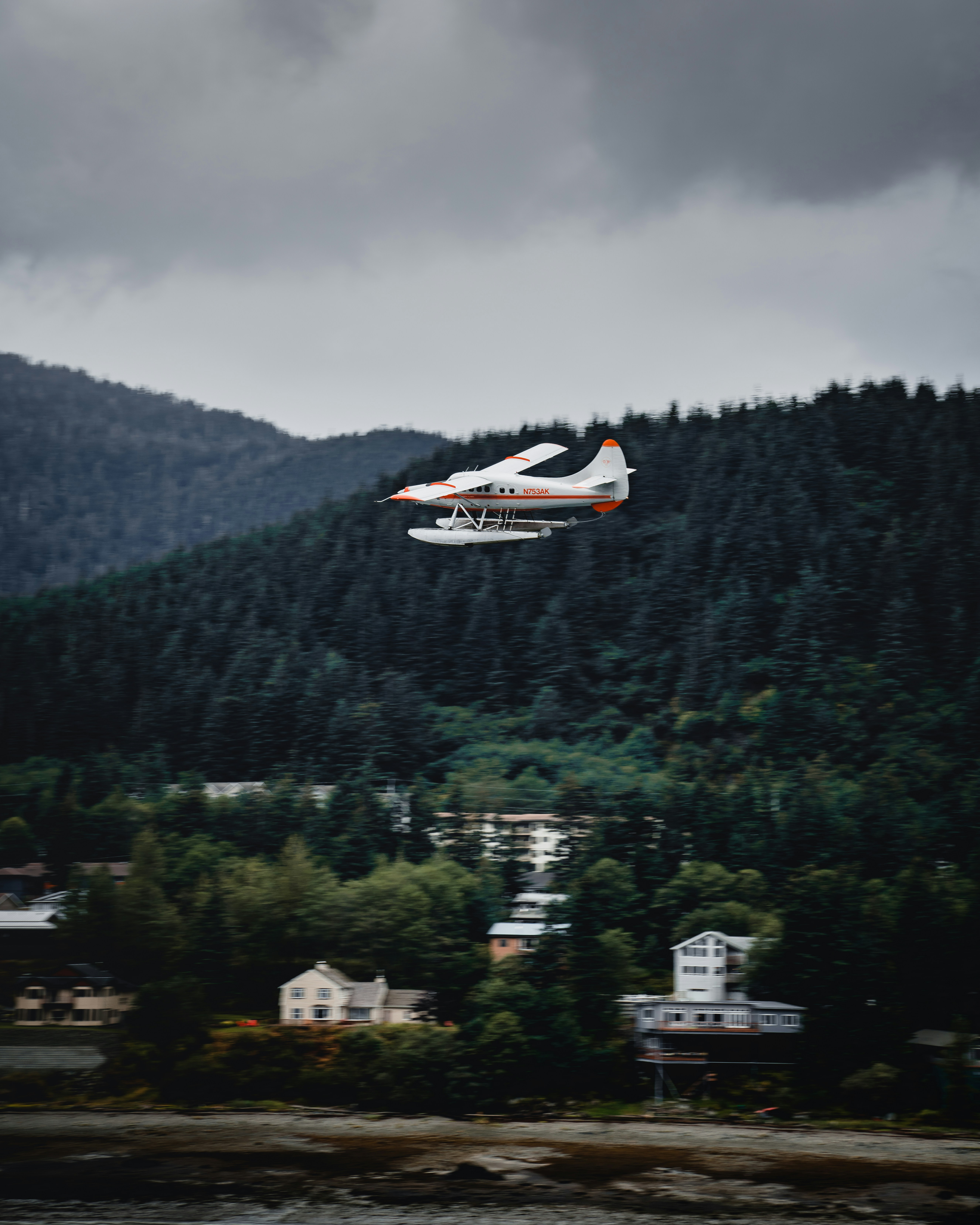 Floating Seaplane Over Quiet Coastal Town