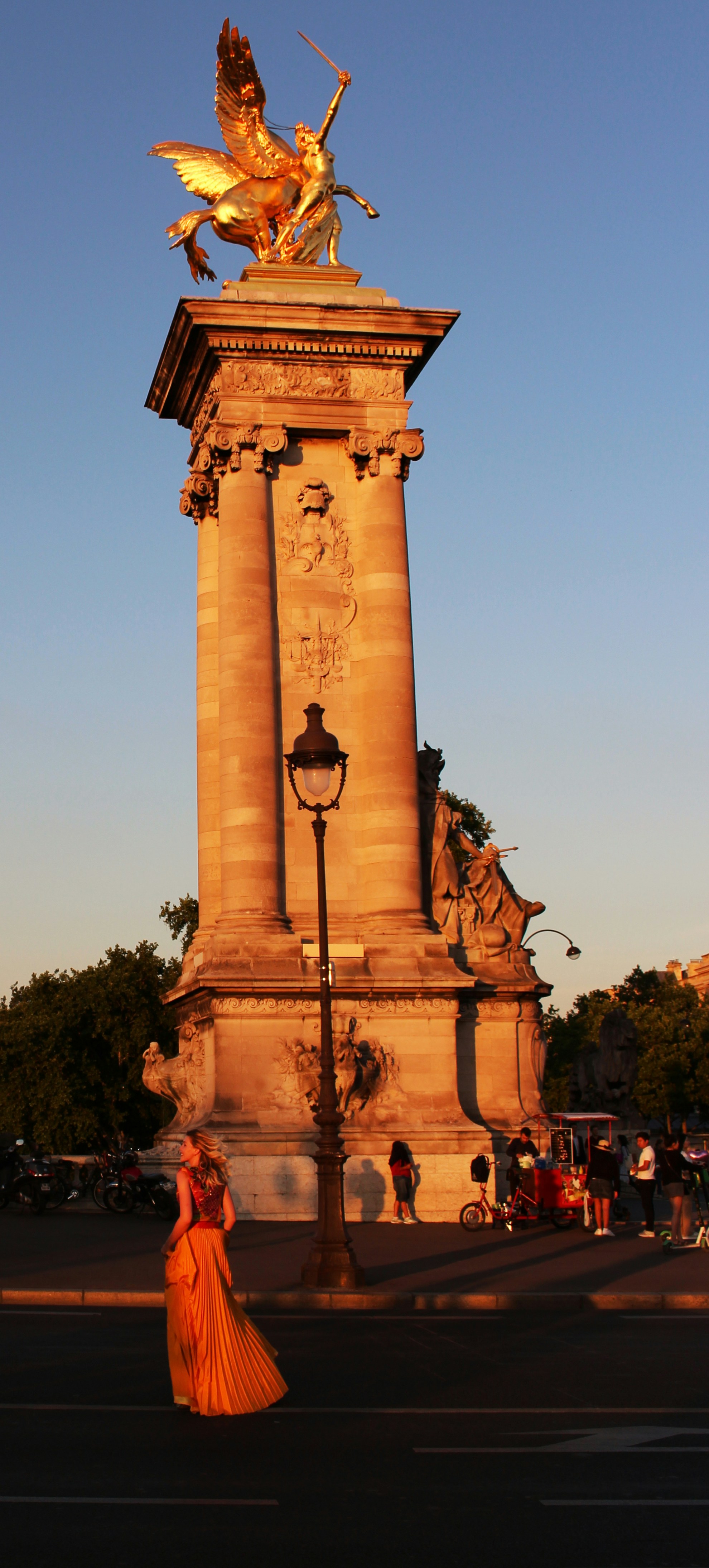 Golden Triumph: Angelic Rider Crowned on a Monumental Pillar at Golden Hour