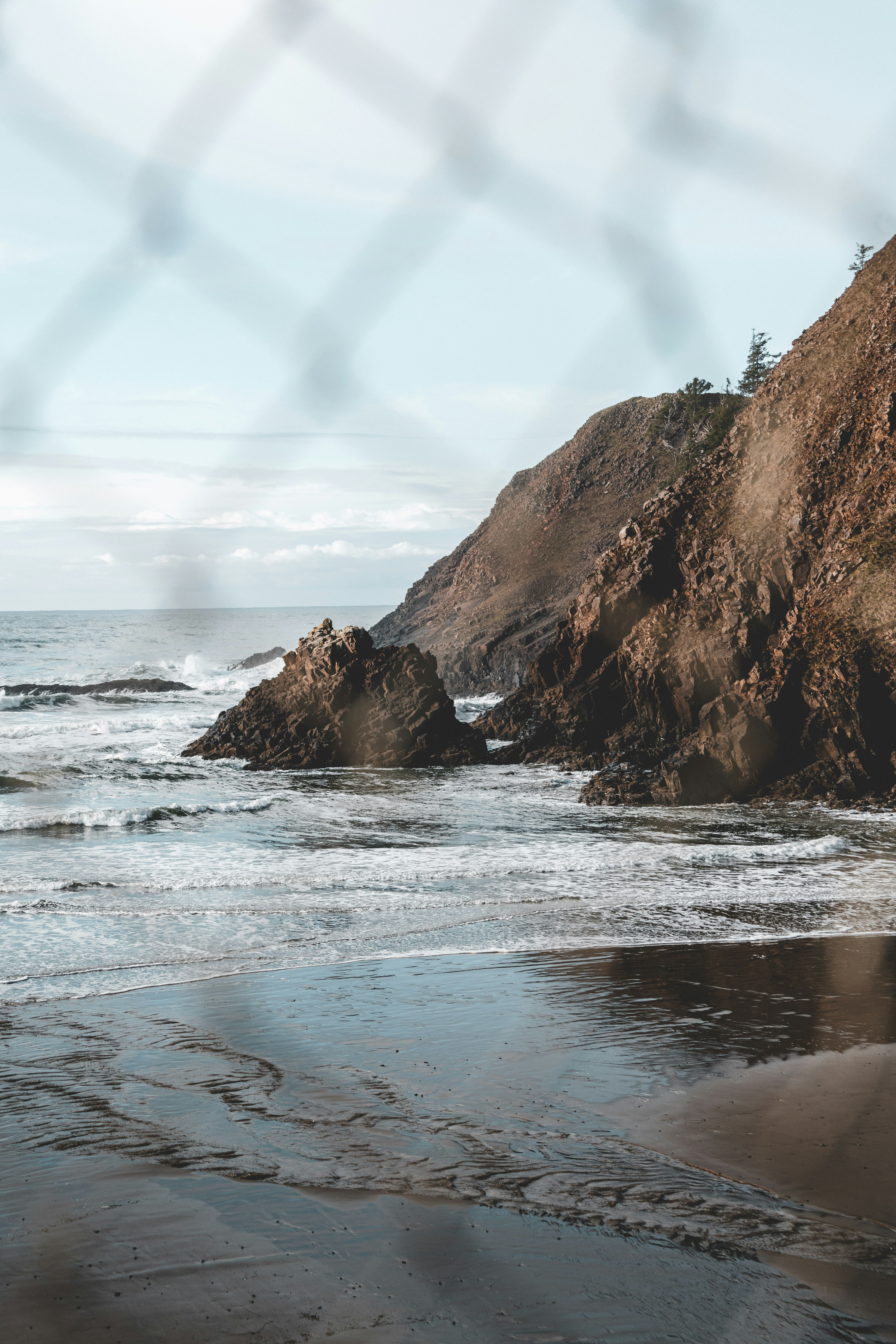 Rugged shoreline guarded by a sunlit cliff